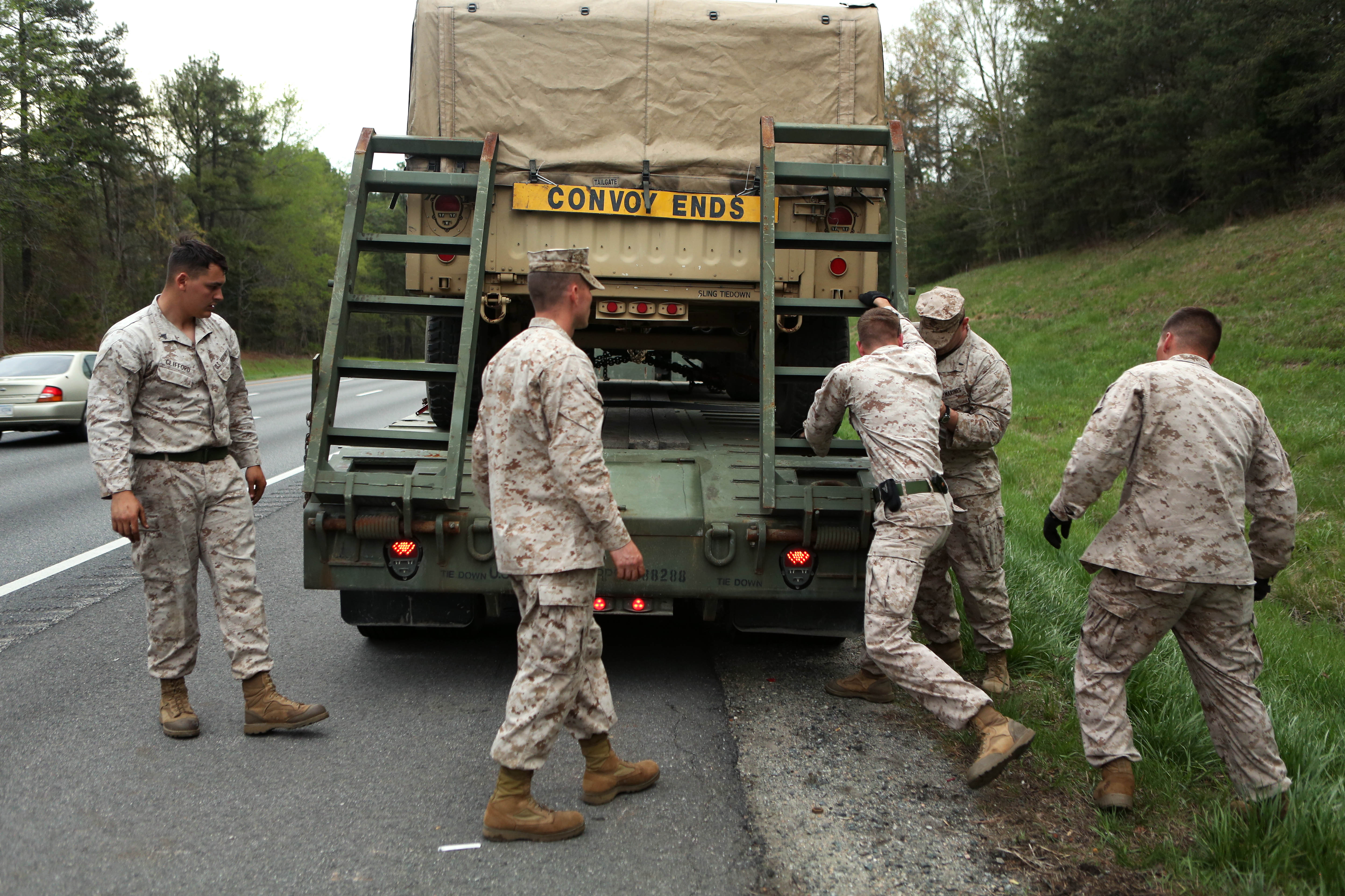Marines secure a Humvee to an MKR16 tractor with an 870 trailer during ...