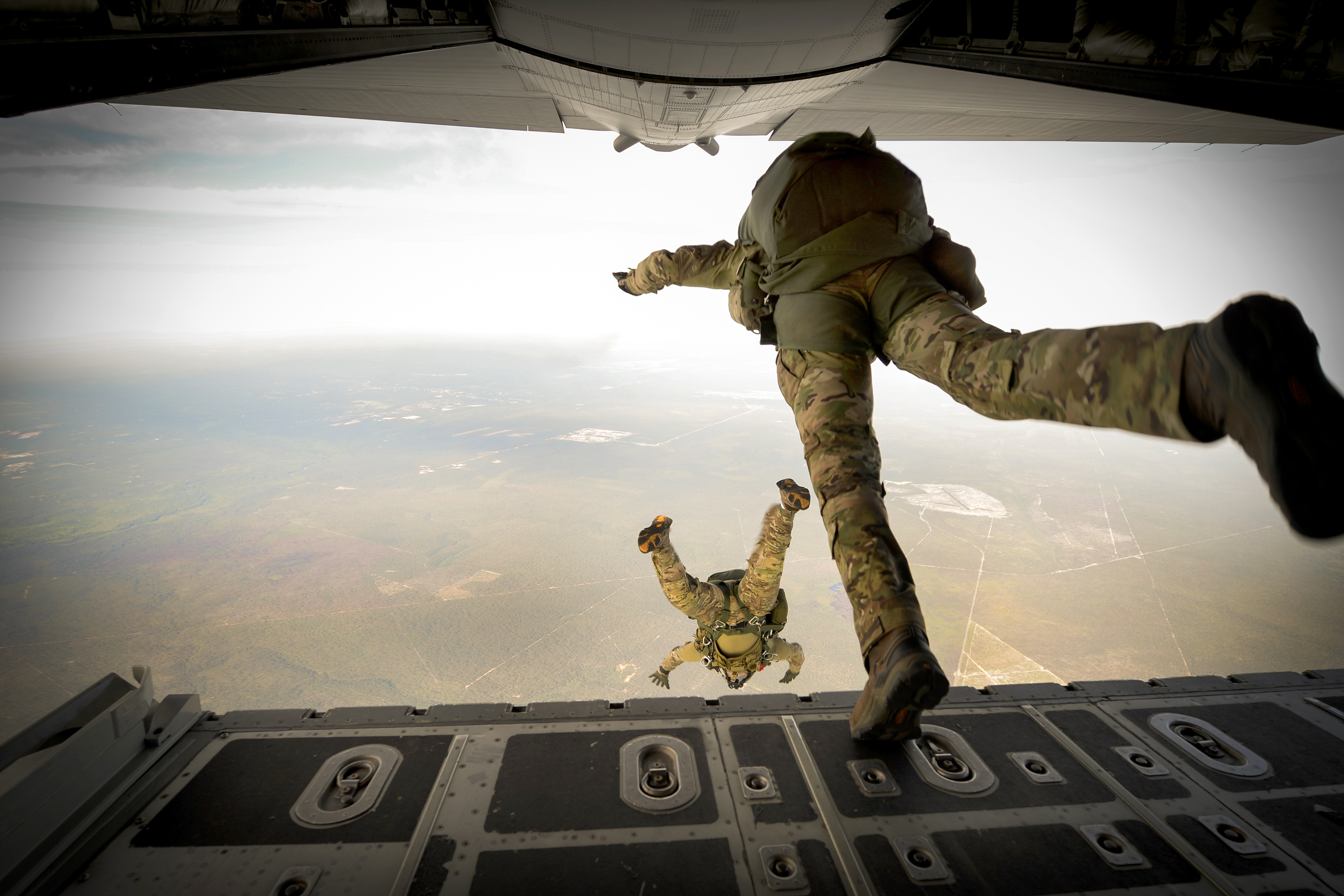 U.S. Army Green Berets jump out of a C-130H3 Hercules aircraft during ...