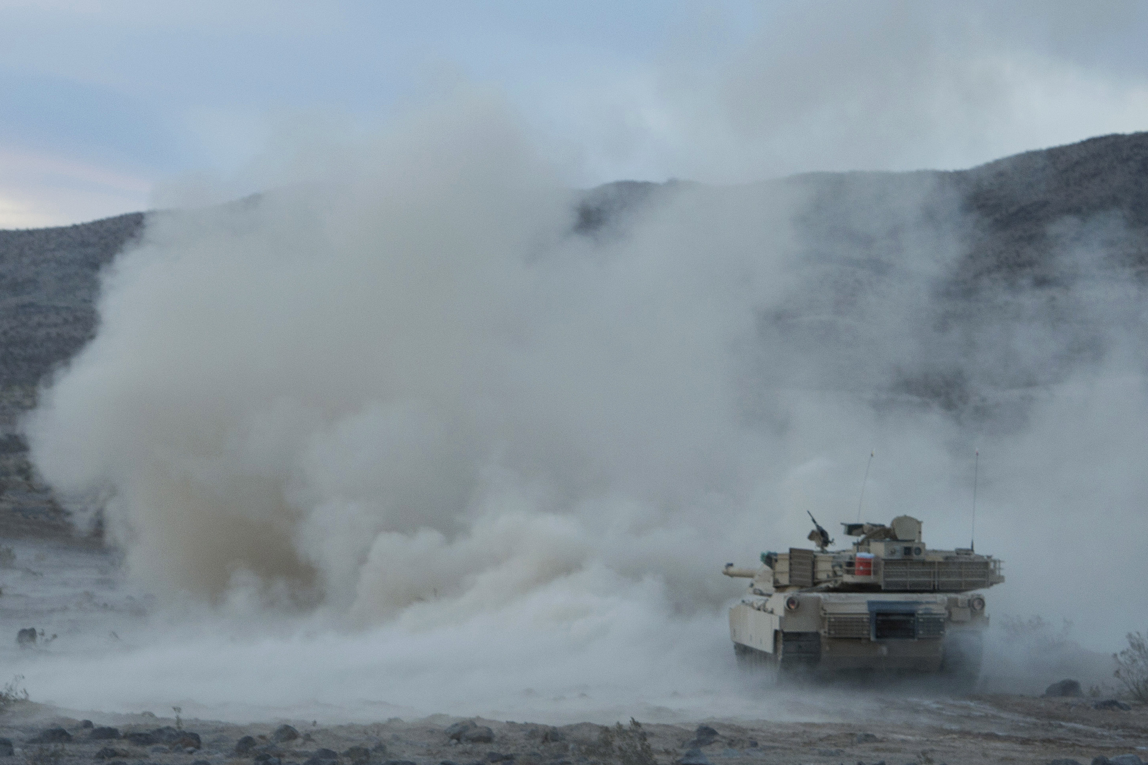 An M1A1 Abrams tank moves and fires its main gun during a live-fire ...