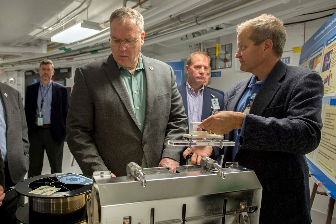 Michael Carter, right, program manager for DoD Programs at the National ...