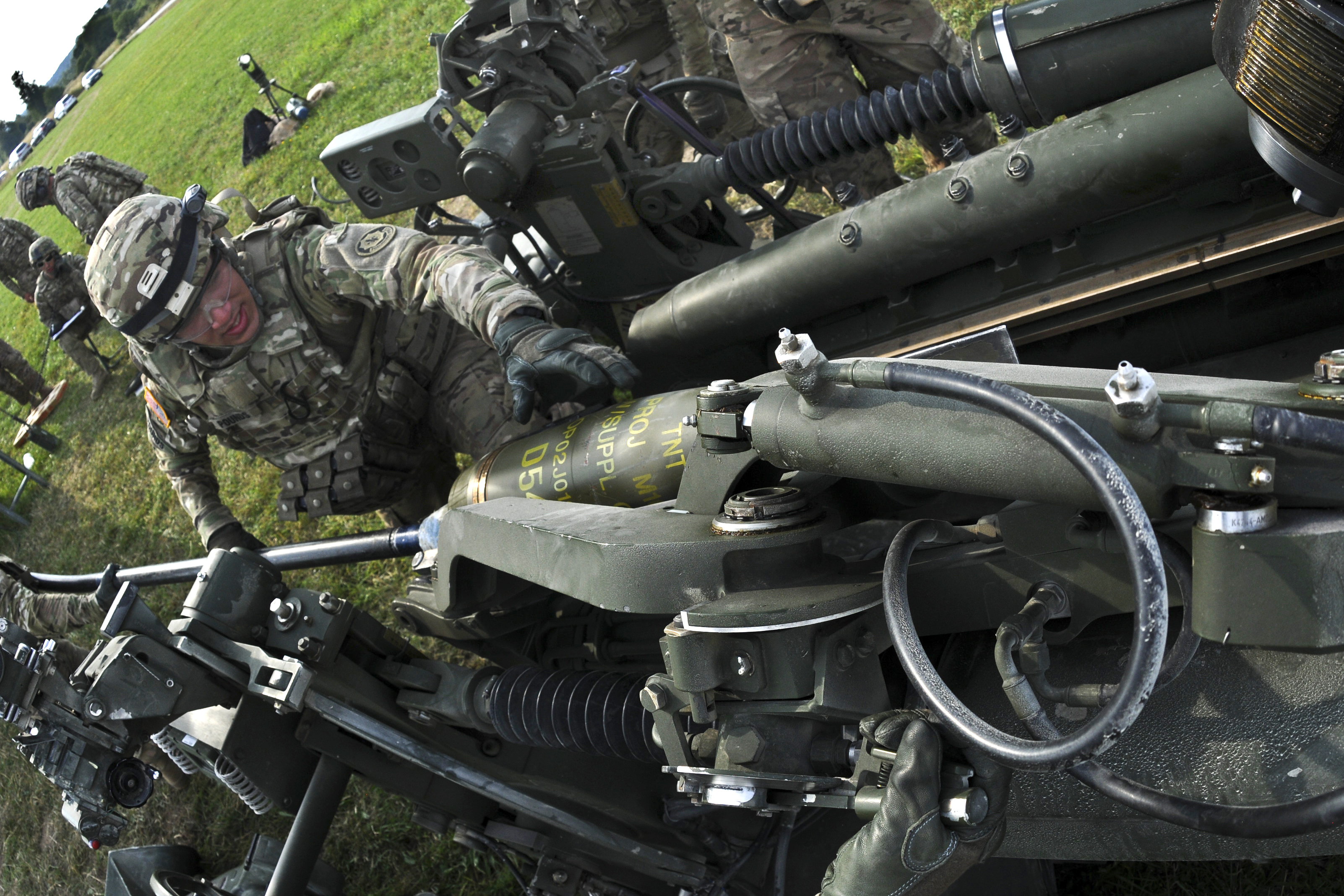 U.S. Army Pfc. Nathaniel Pounds loads ammunition into an M777A2 ...