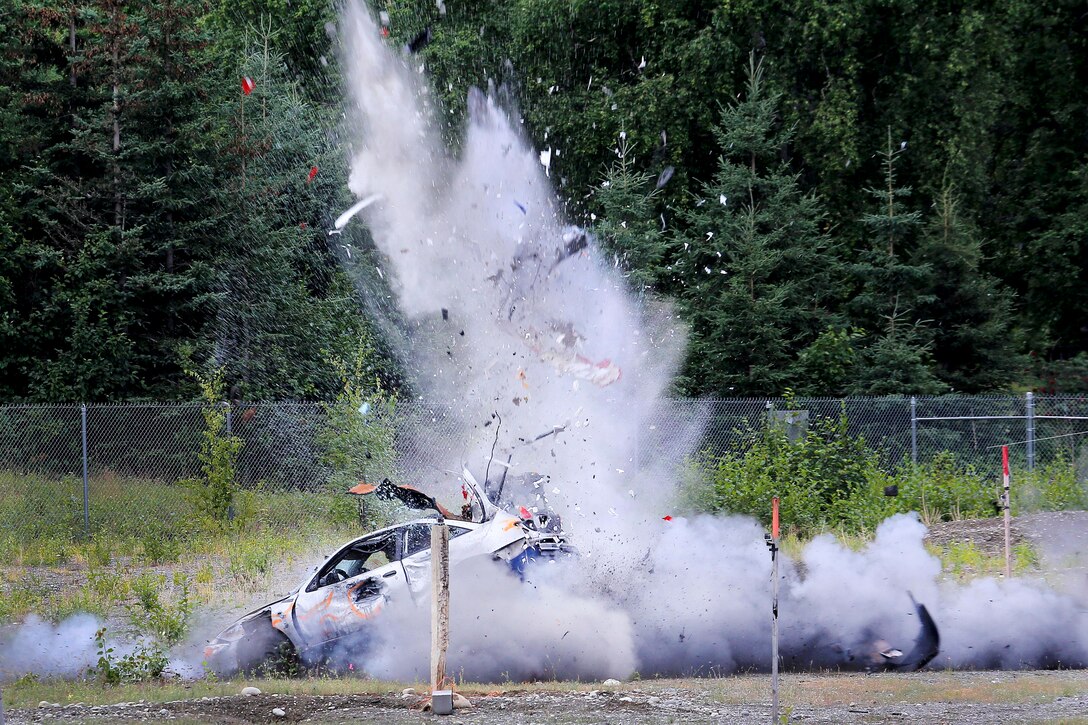 An explosive device is control-detonated under a car to demonstrate the ...