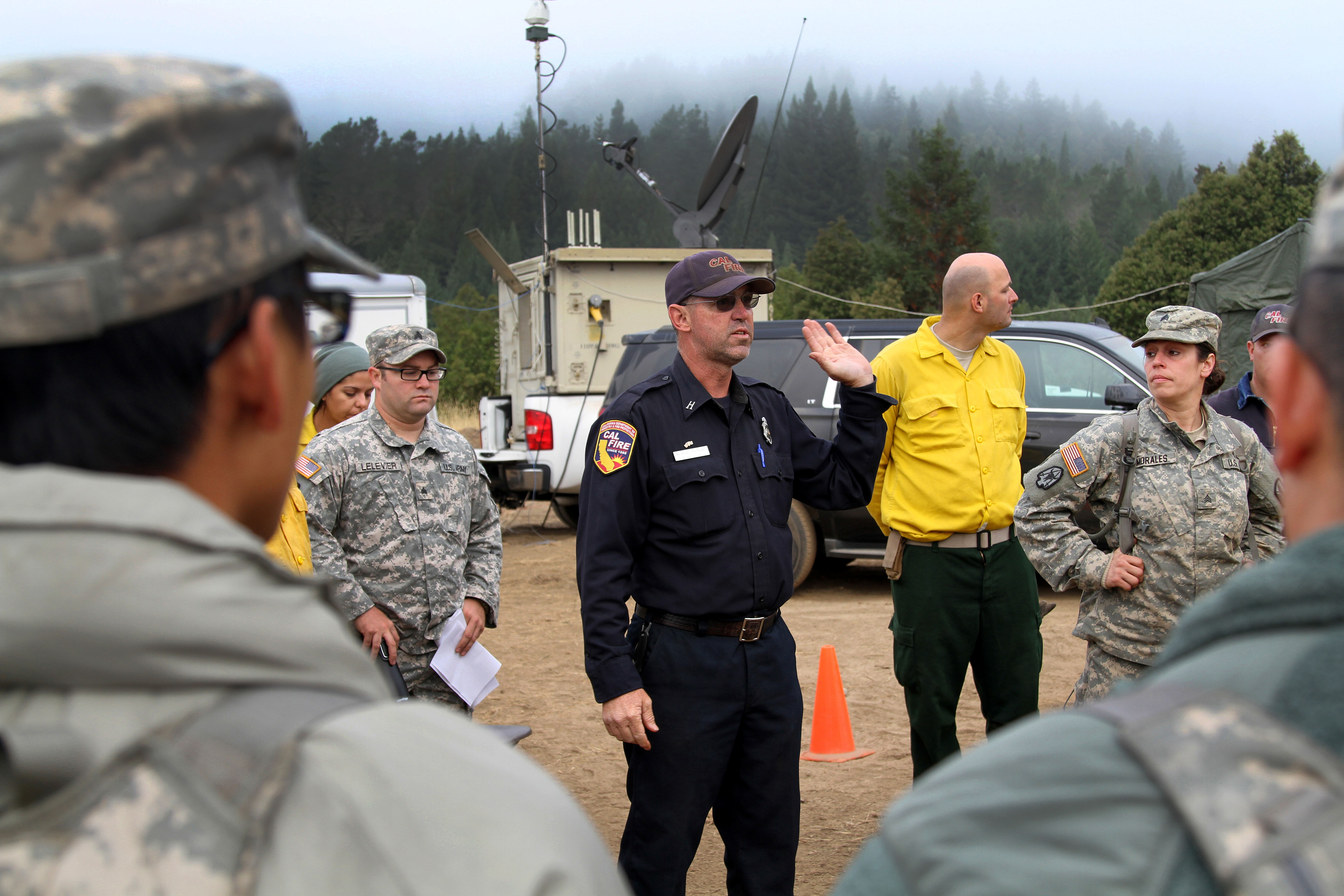 Michael Steineke, center, Cal Fire’s military liaison to the California ...