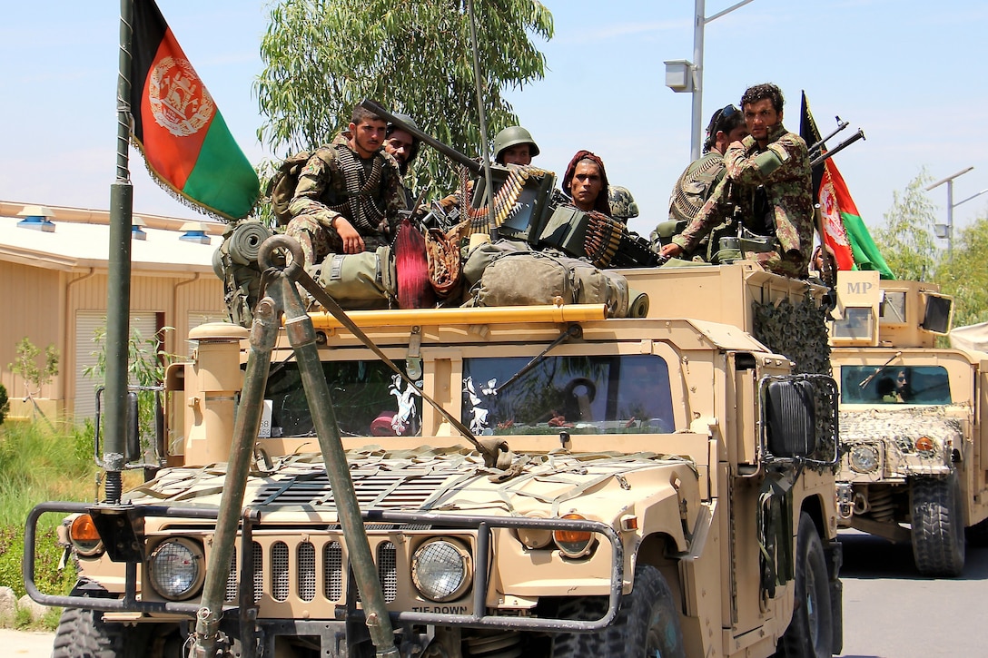 Afghan National Army troops move out from the 201 Corps headquarters at ...