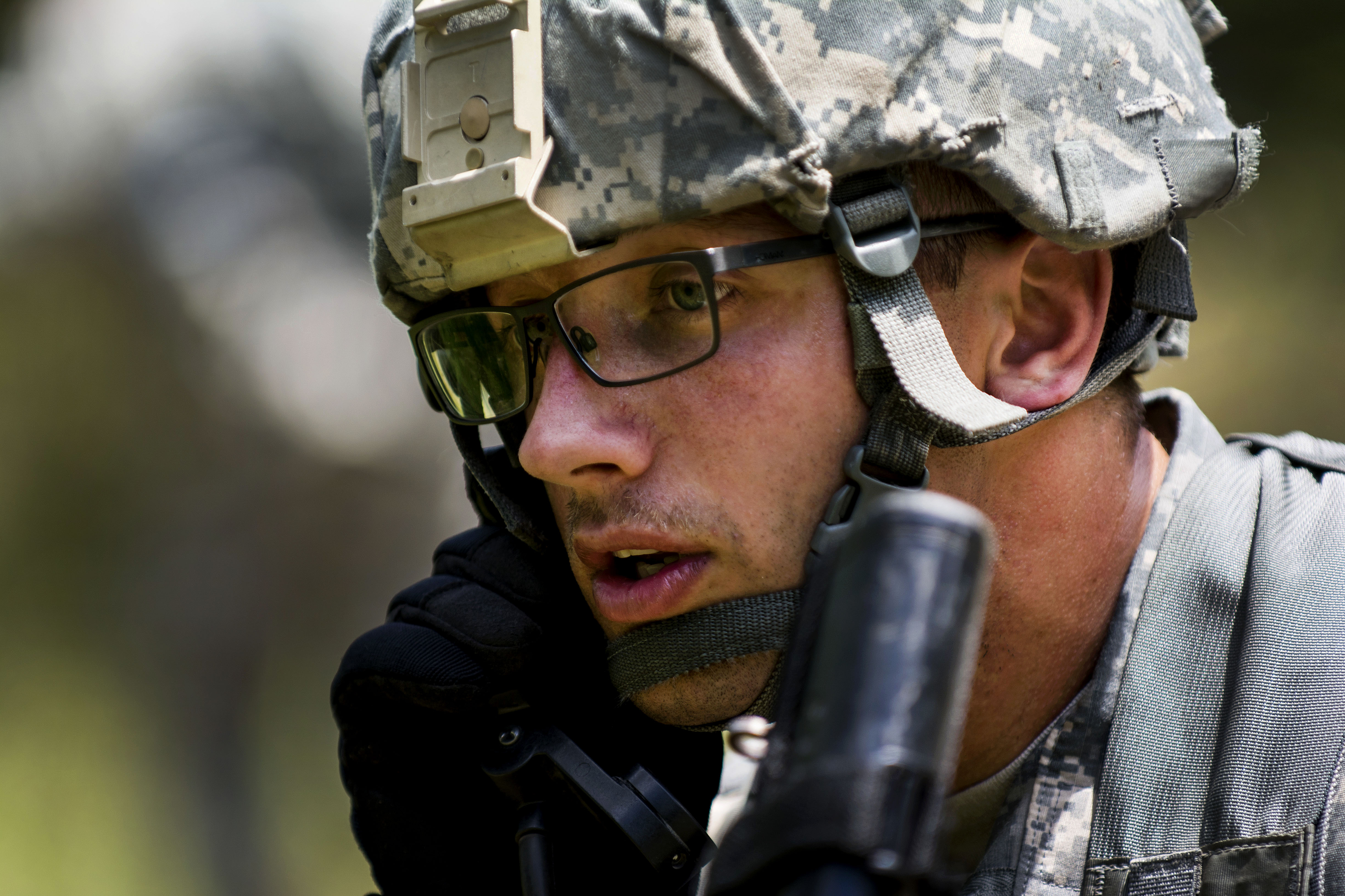 Army Spc. Jed Lechner communicates by radio during a simulated air ...