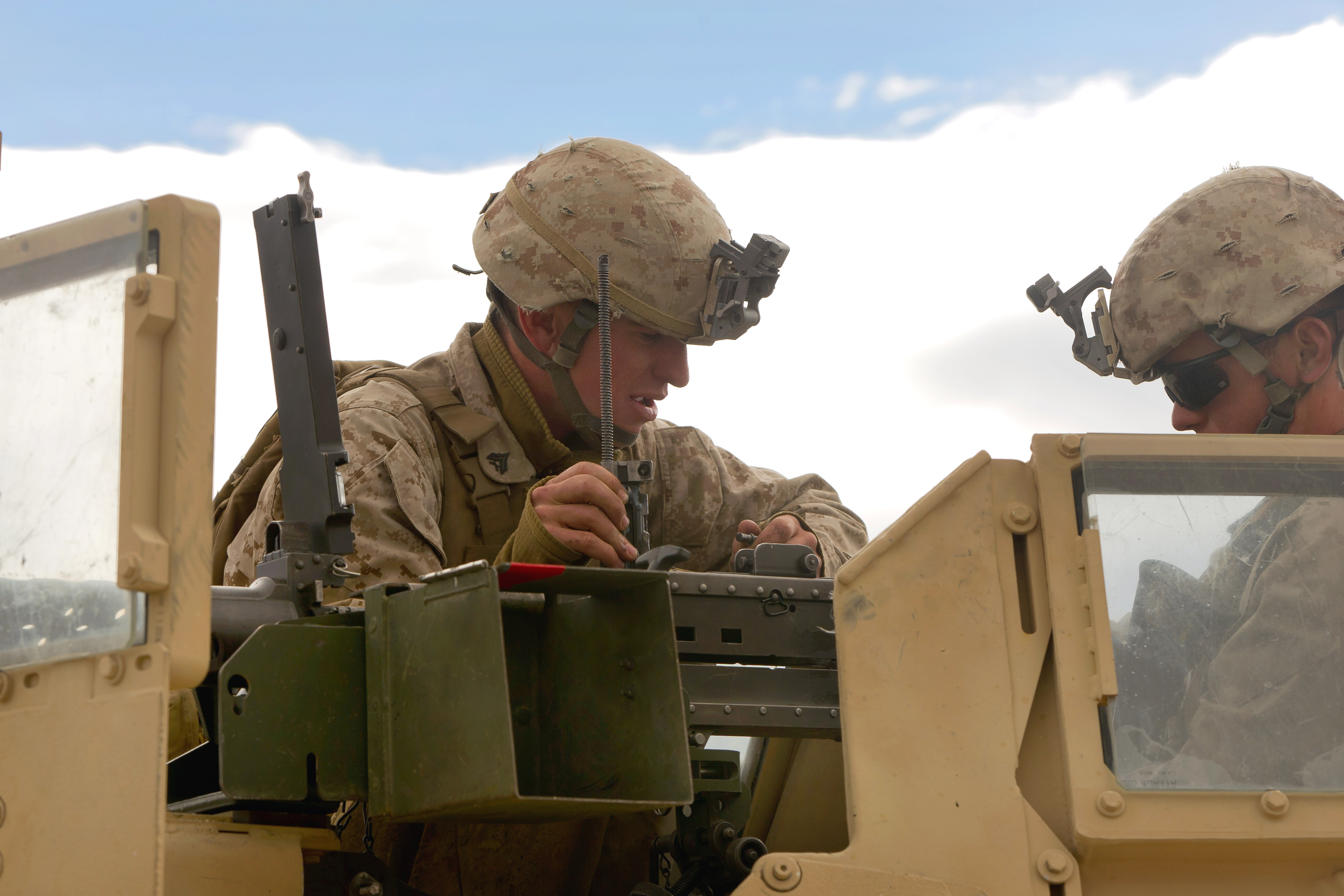 Marines set up a .50-caliber machine gun atop a Humvee while ...