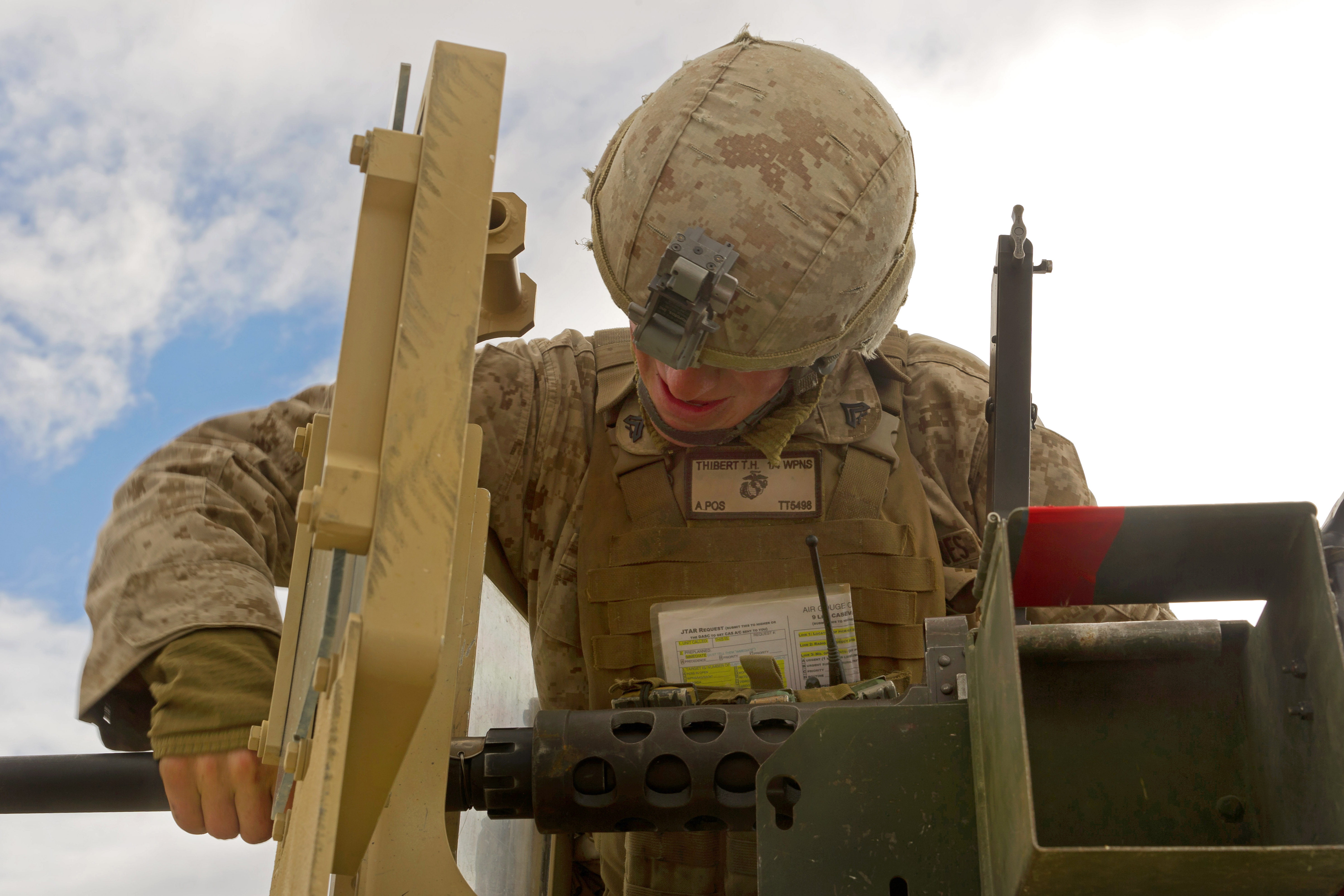 Marine Corps Cpl. Thibert sets up a .50-caliber machine gun atop a ...