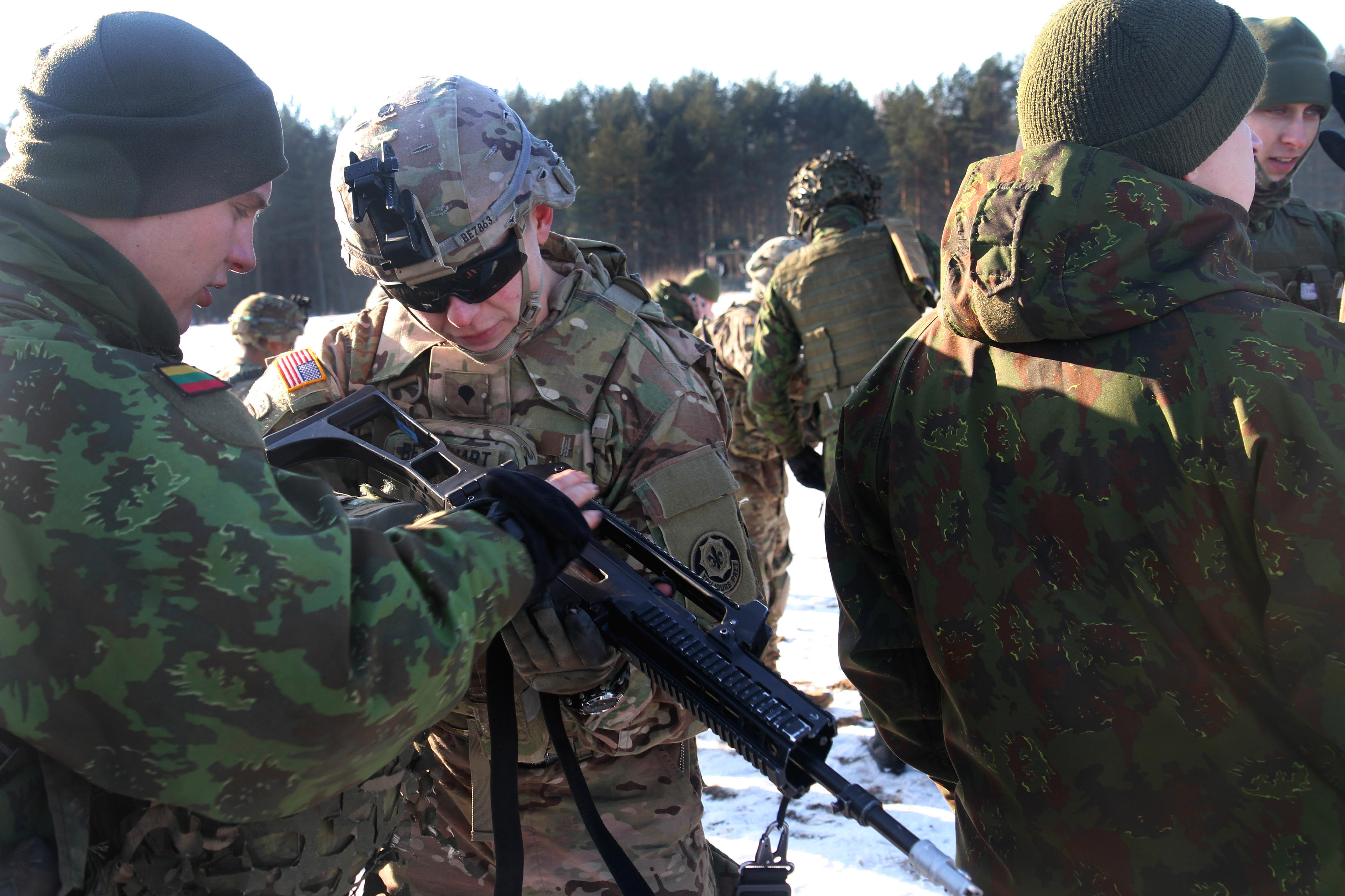 A Lithuanian soldier, left, explains his weapons operation to a U.S ...