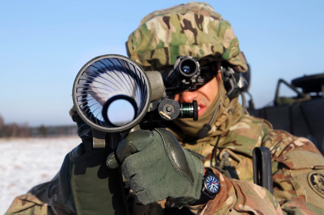 A U.S. soldier looks through the sight of a Lithuanian rocket launcher ...