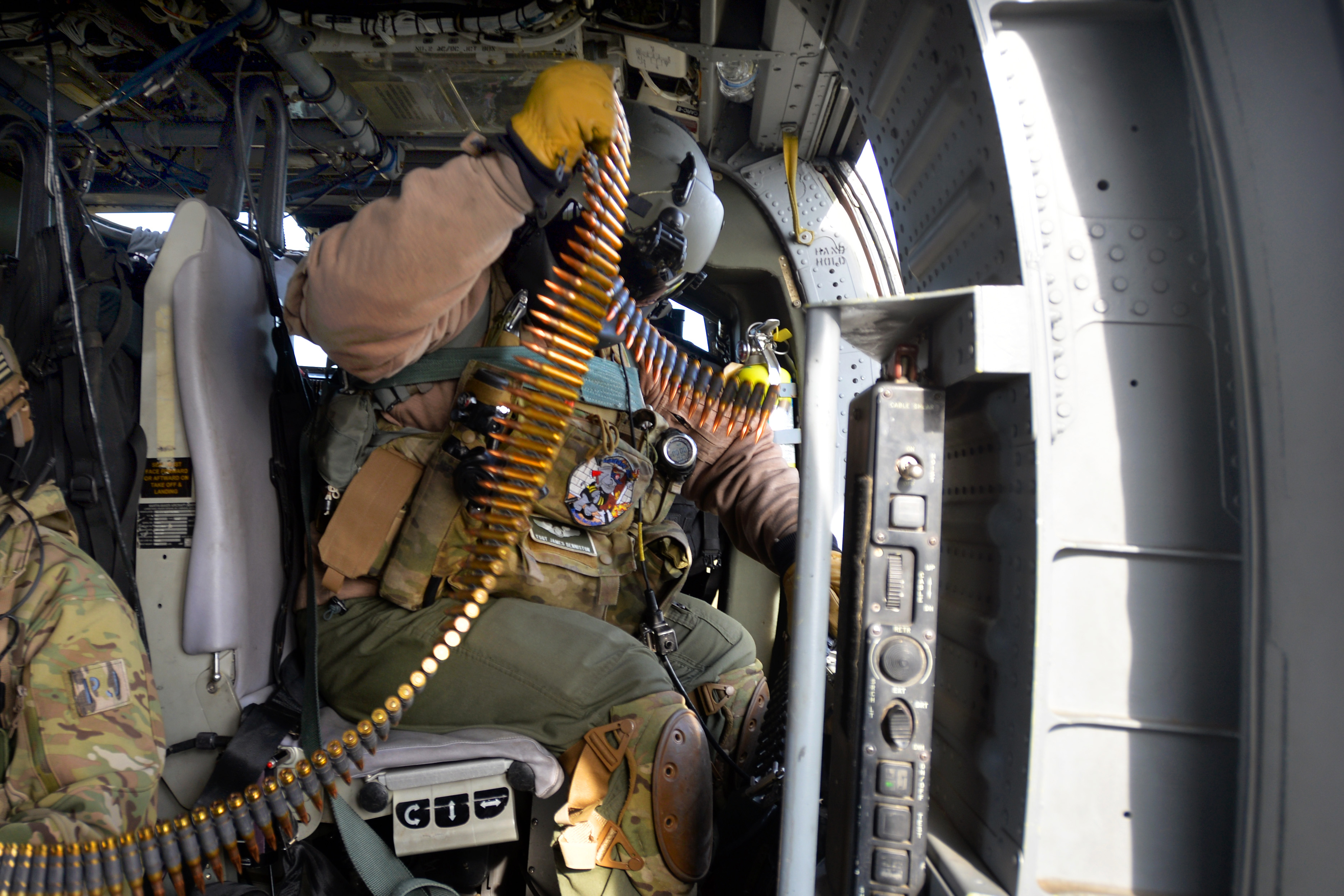 An Air National Guard airman loads a belt of rounds into a Gau 2 ...