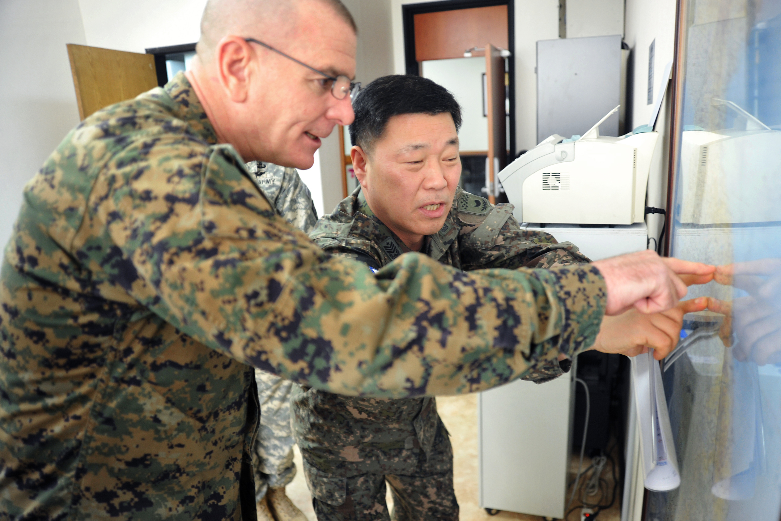 South Korean Command Sgt. Maj. Lee Gil-ho, right, points out where his ...