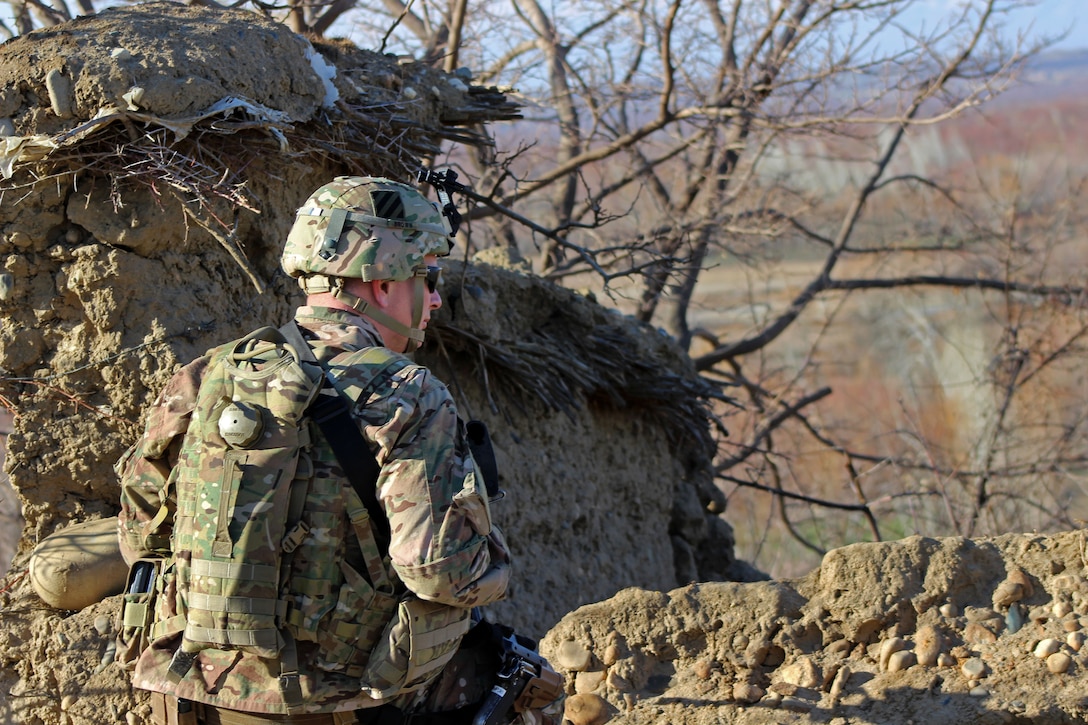 U.S. Army Sgt. Christopher Brown provides security from behind a ...