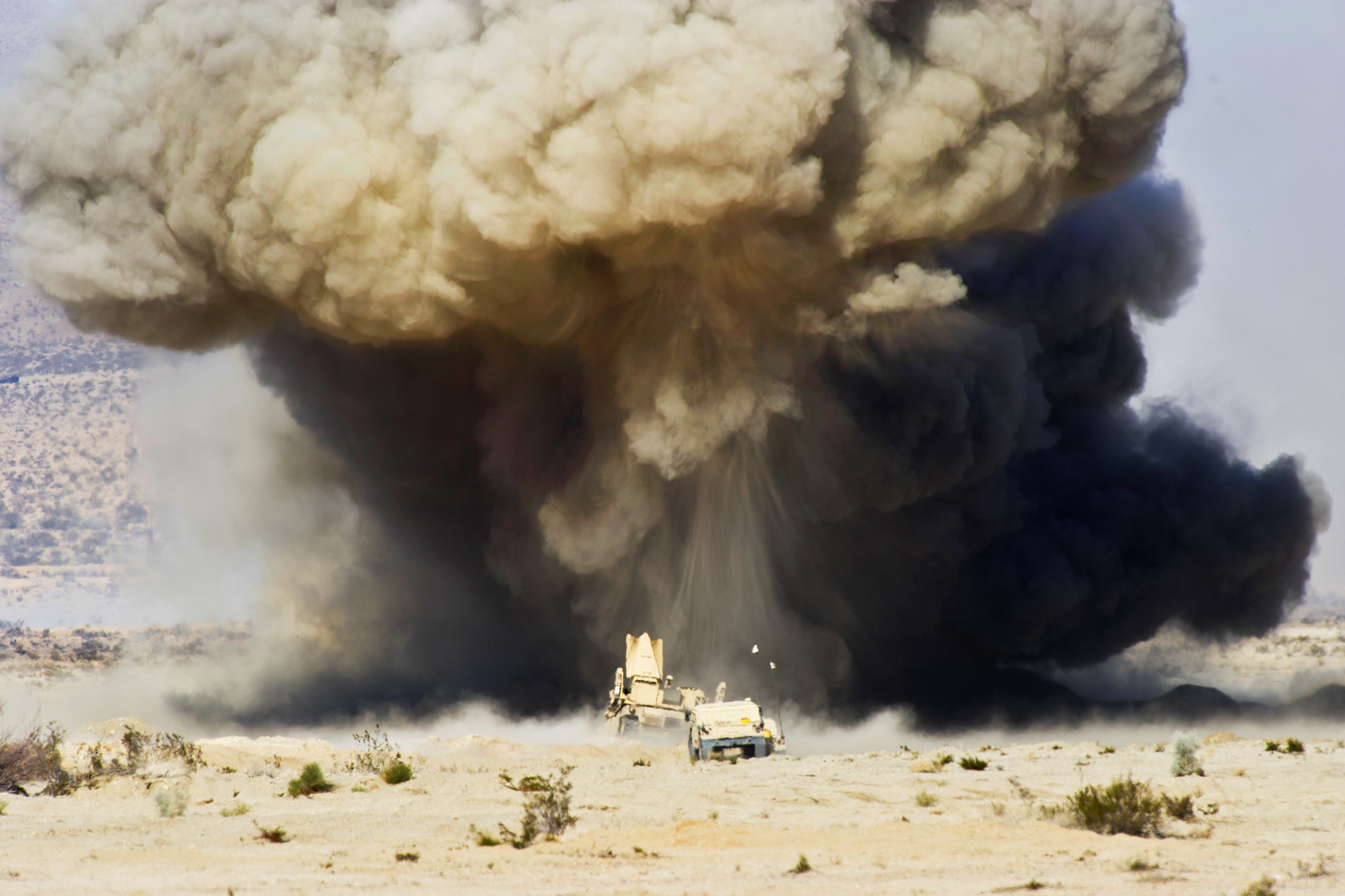 A Marine Corps assault breaching vehicle detonates a mine clearing line ...