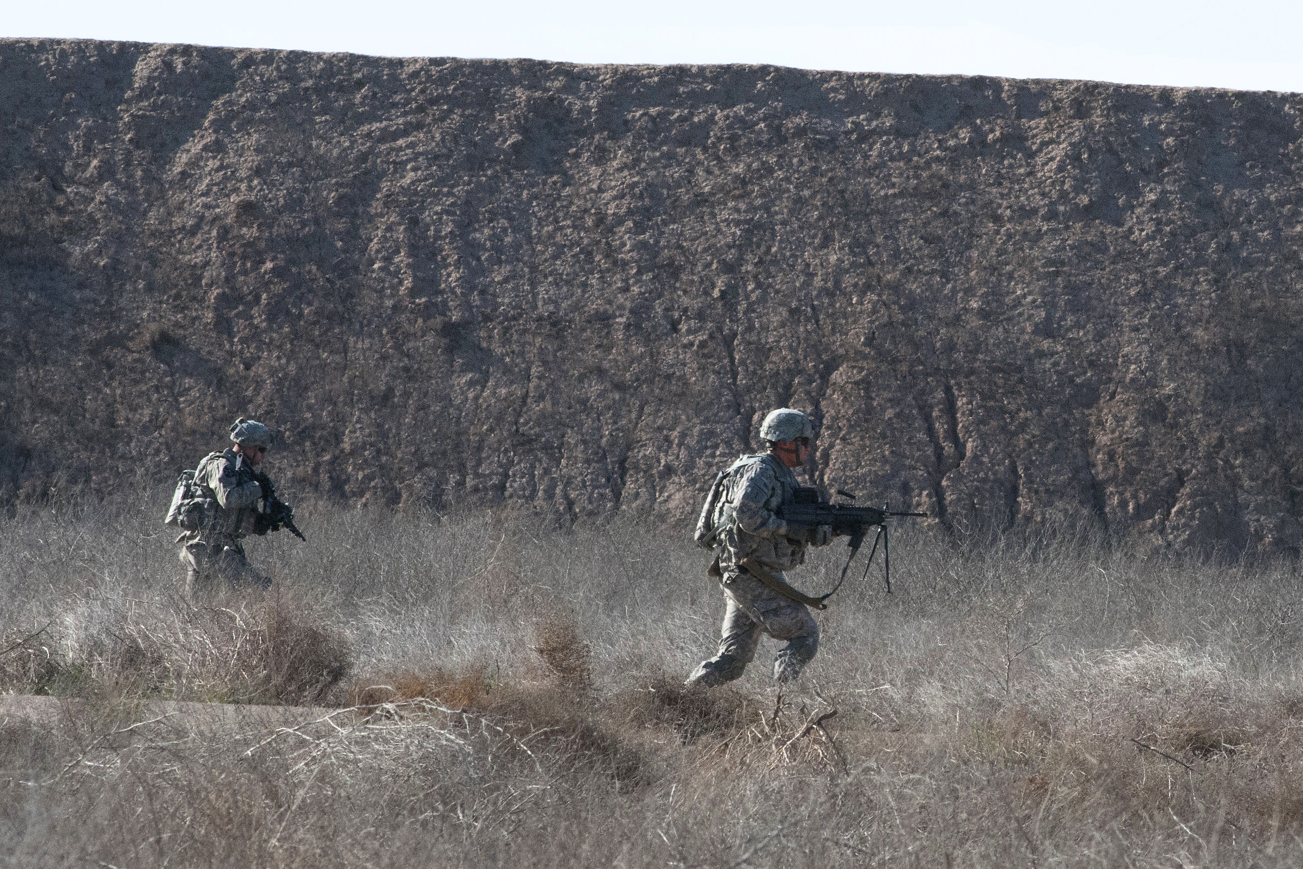 U.S. soldiers move as a buddy team during a platoon live-fire ...