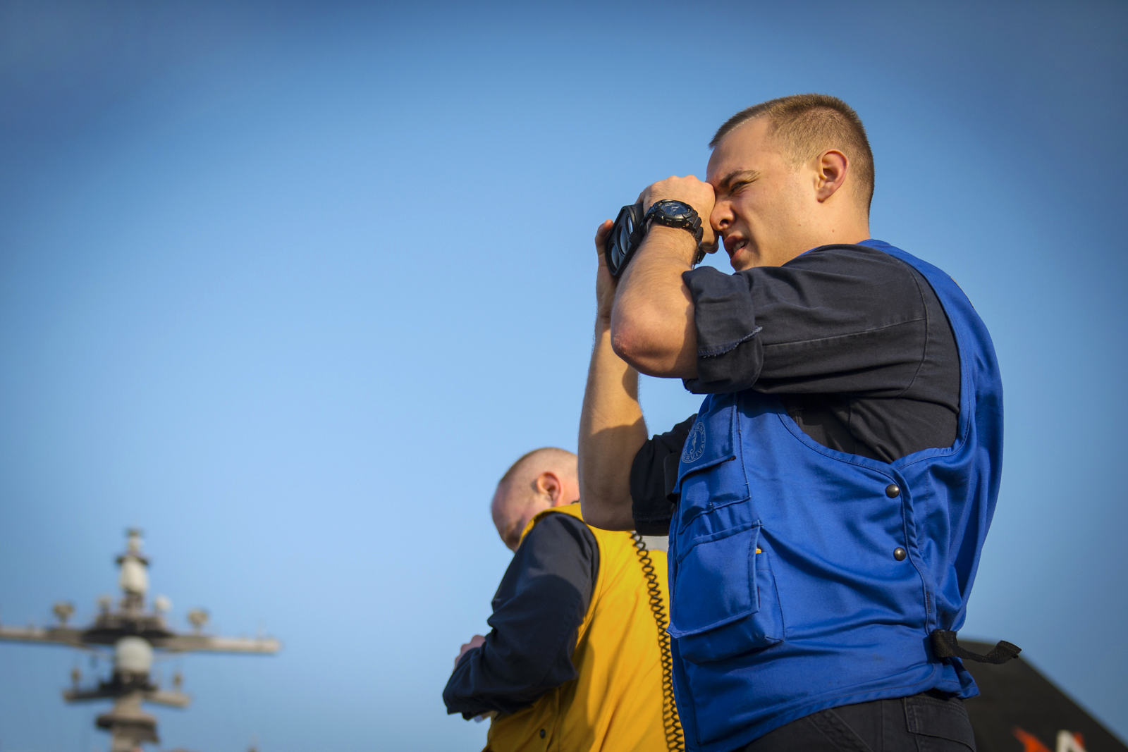U.S. Navy Petty Officer 3rd Class Christopher Teeter monitors distance ...