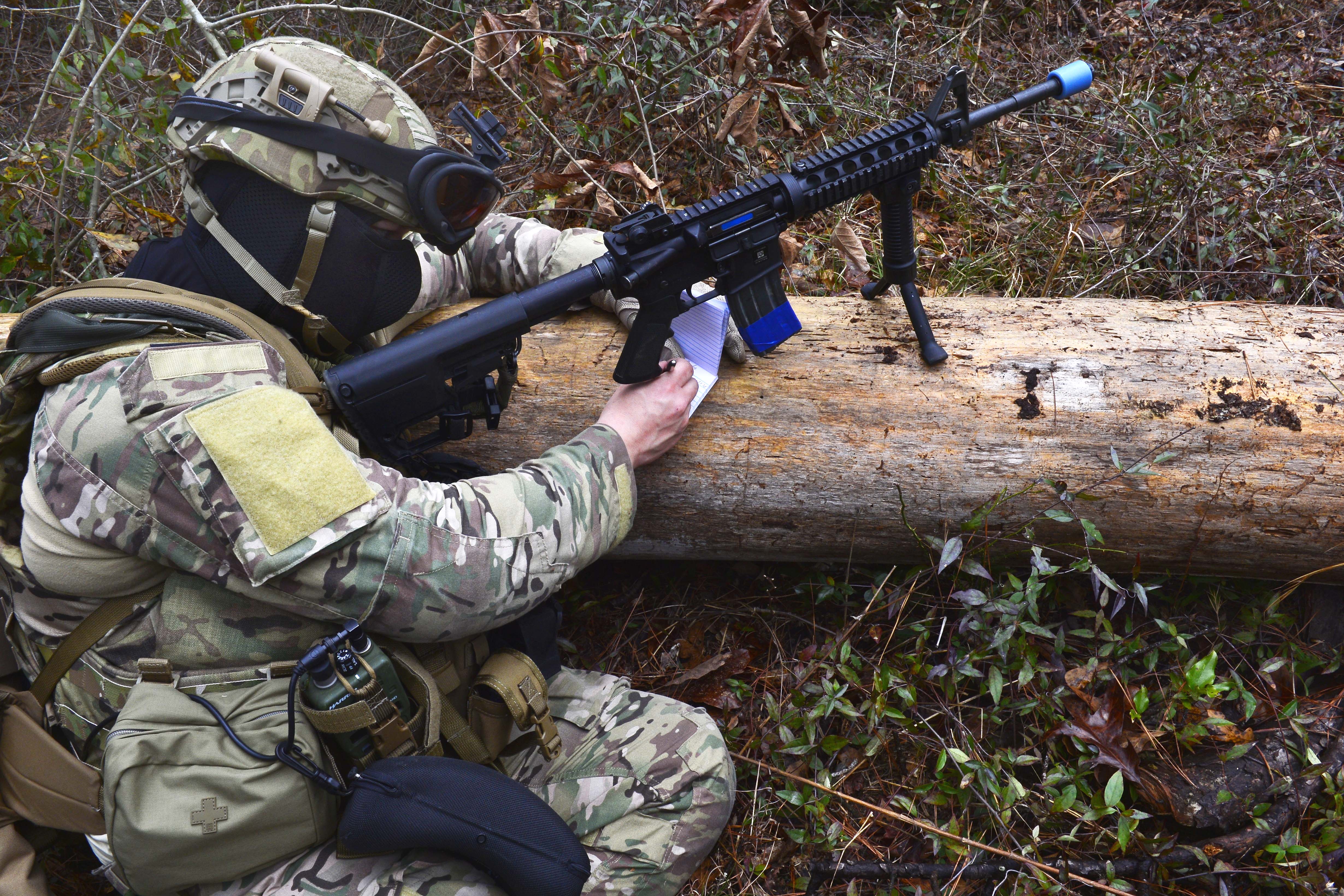Air Force Senior Airman Michael Schaffer jots down characteristics of a ...