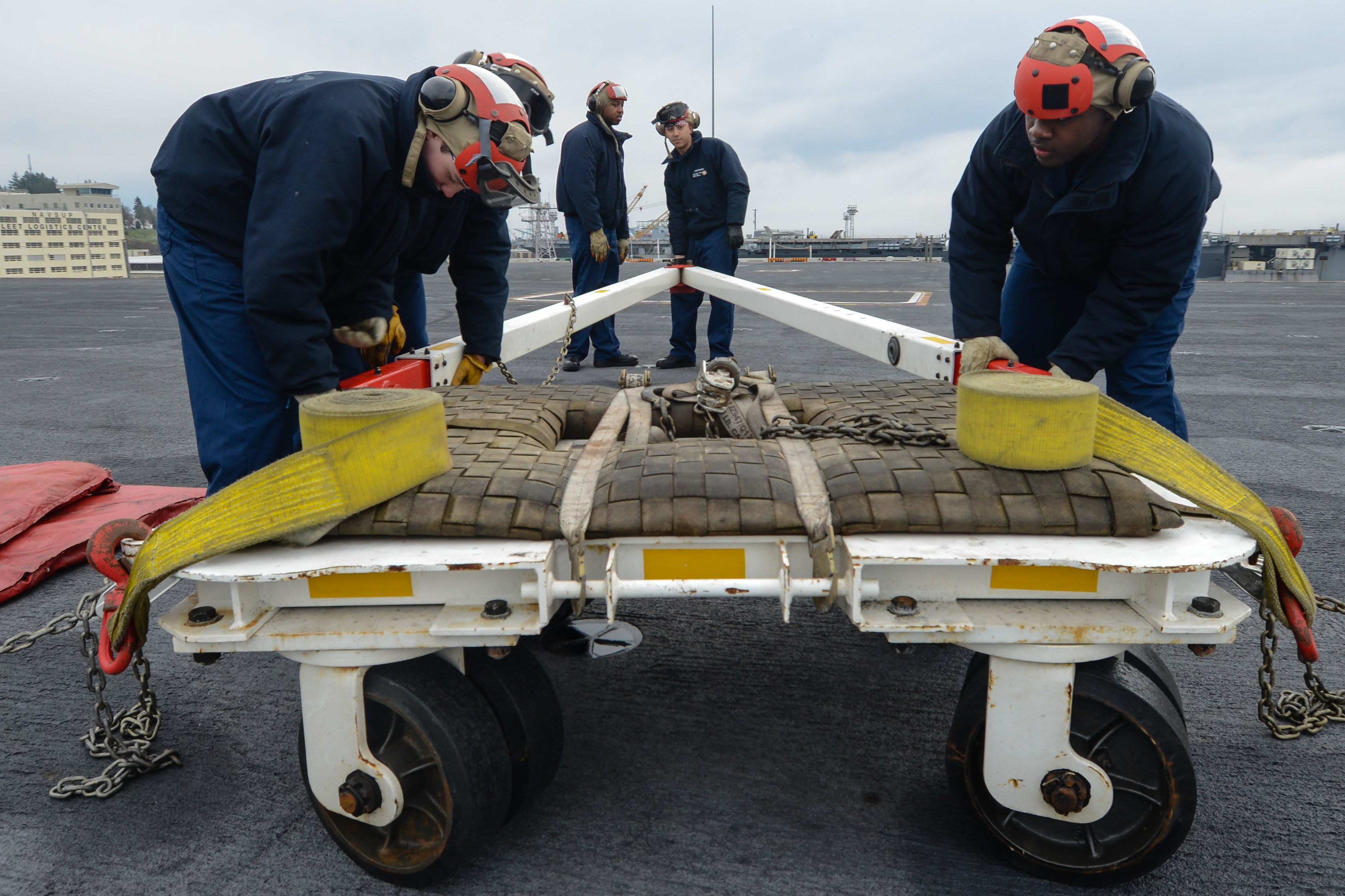 U.S. Navy sailors put together a towing dolly on the USS John C ...