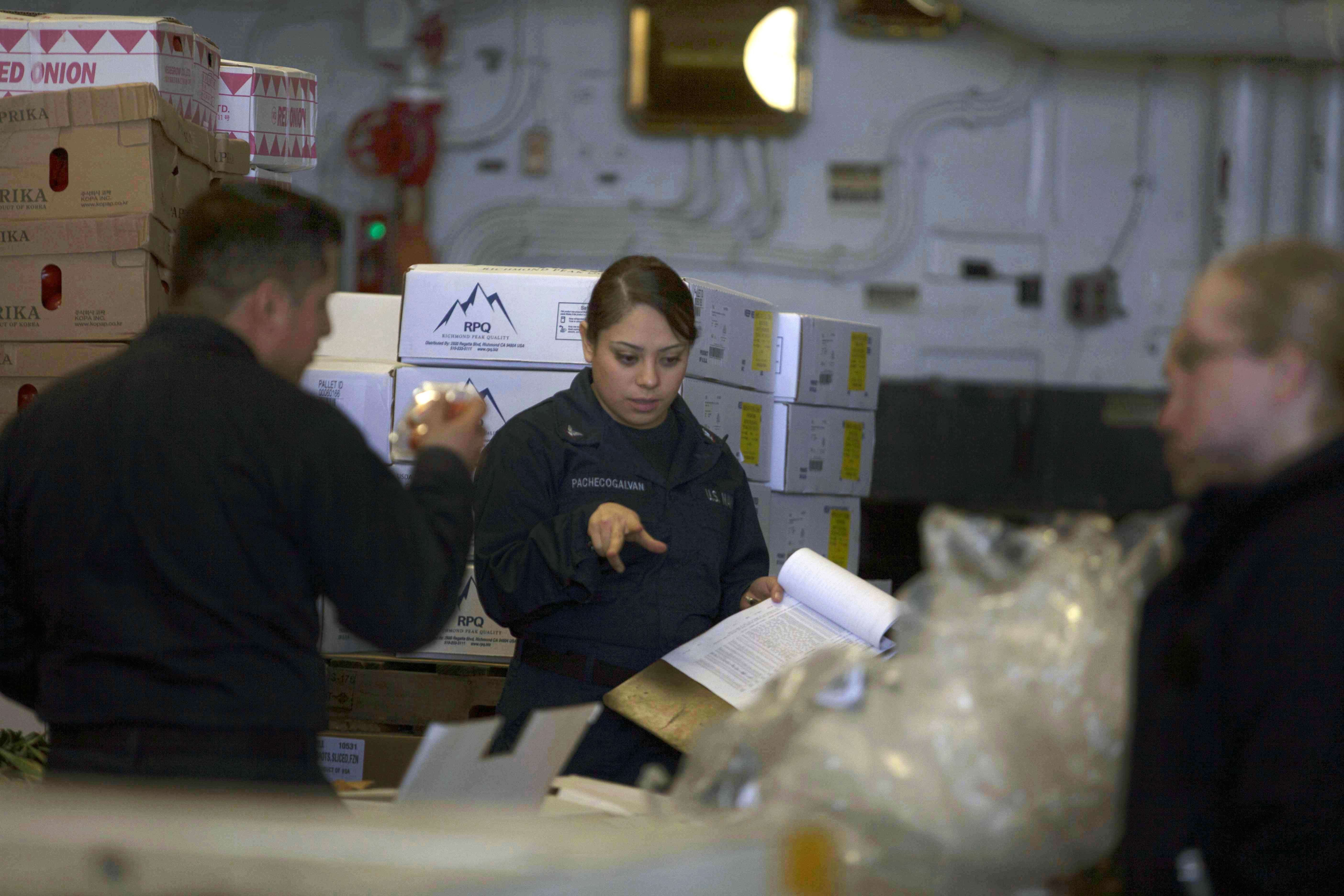 U.S. Navy sailors take inventory of food and supplies delivered during ...