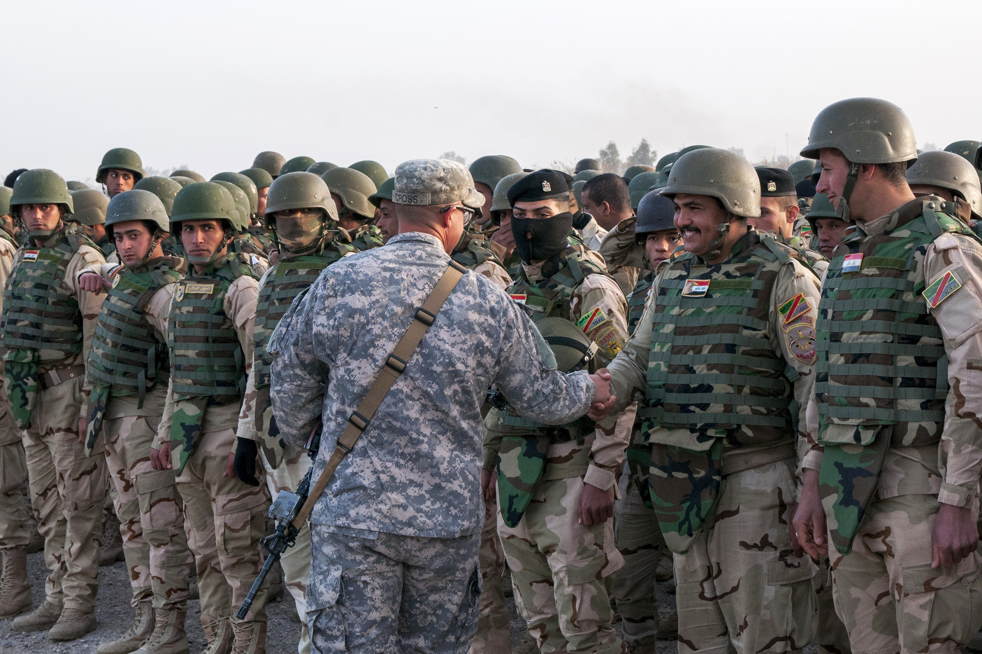U.S. Army Staff Sgt. Kody Cross, center, congratulates Iraqi army ...