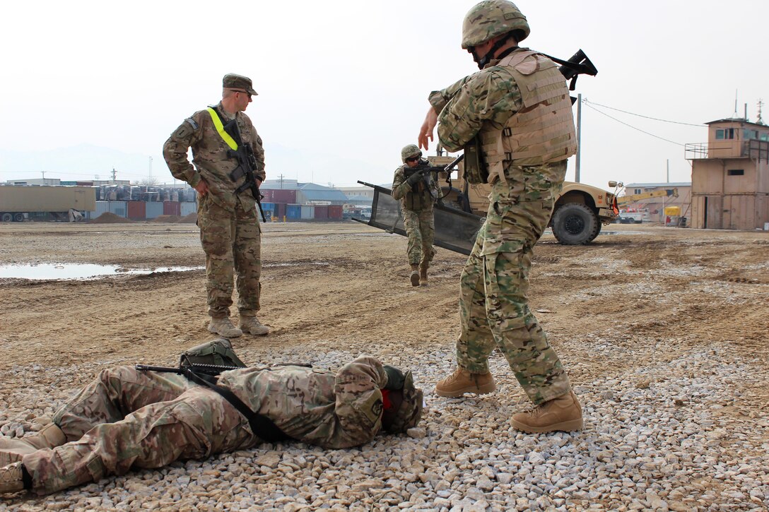 A U.S. soldier watches as Georgian soldiers respond to a possible ...