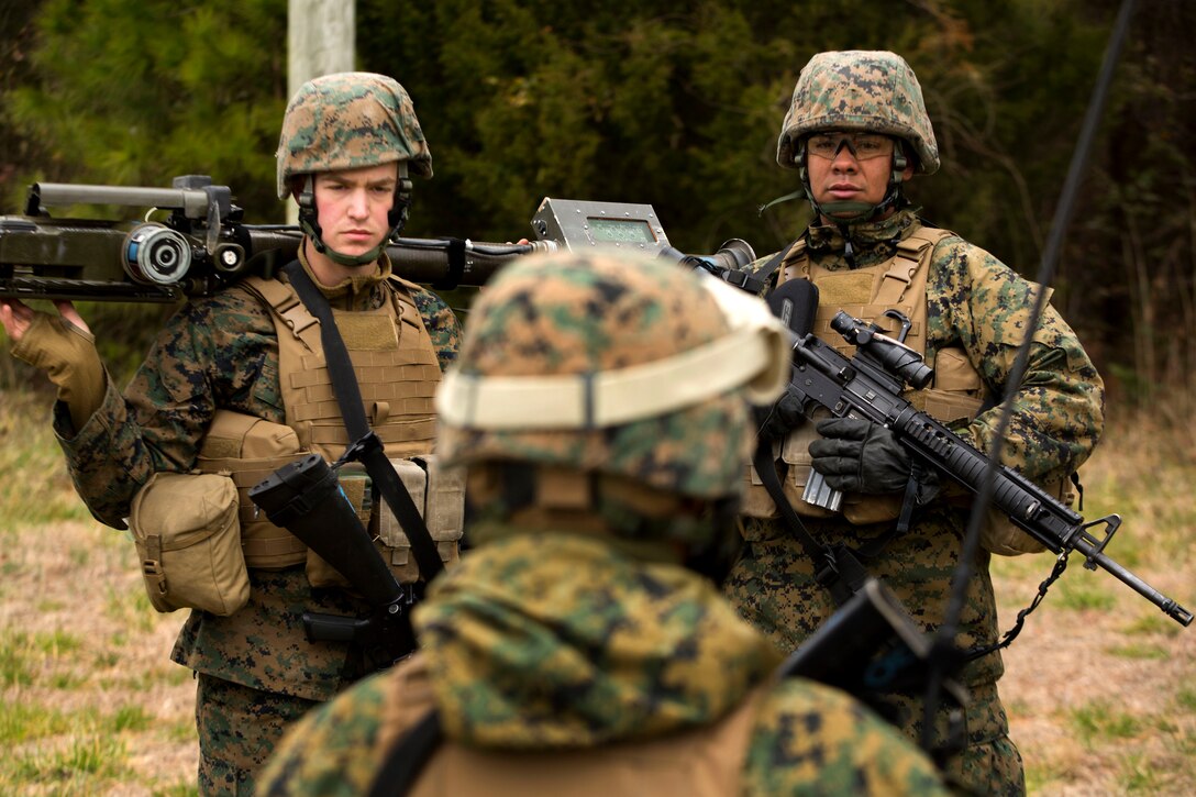 Marine Corps 1st Lt. Michael Alvarado, foreground briefs his Marines ...