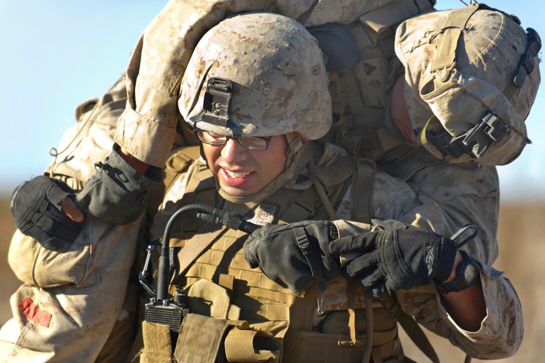 Navy Seaman Antonio Cordova Jr. transports a patient using a fireman's ...