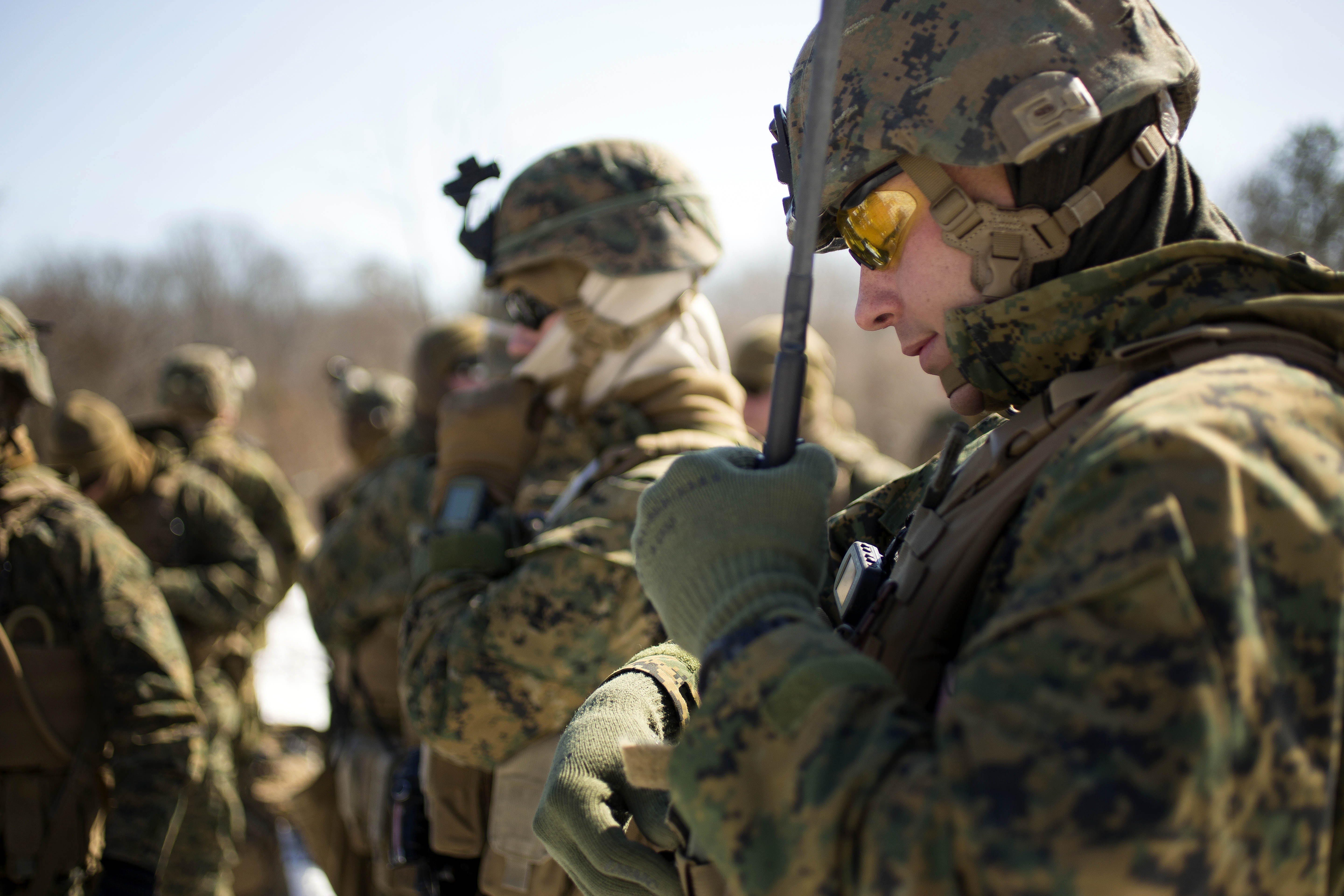 Marine Corps Sgt. Justin R. Kelley, right, secures his PRC-152 ...