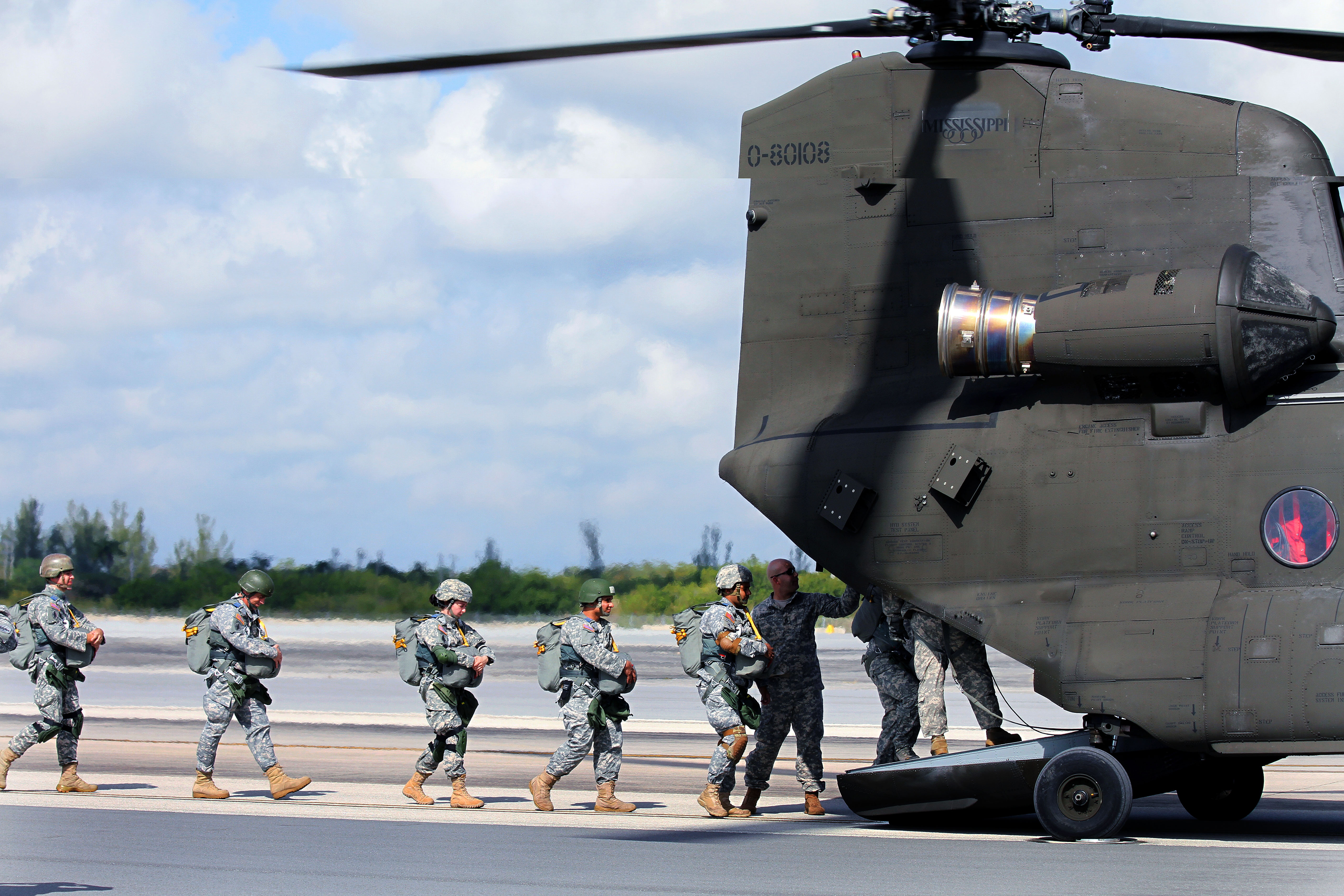 Army paratroopers walk to board a CH-47 Chinook helicopter before ...