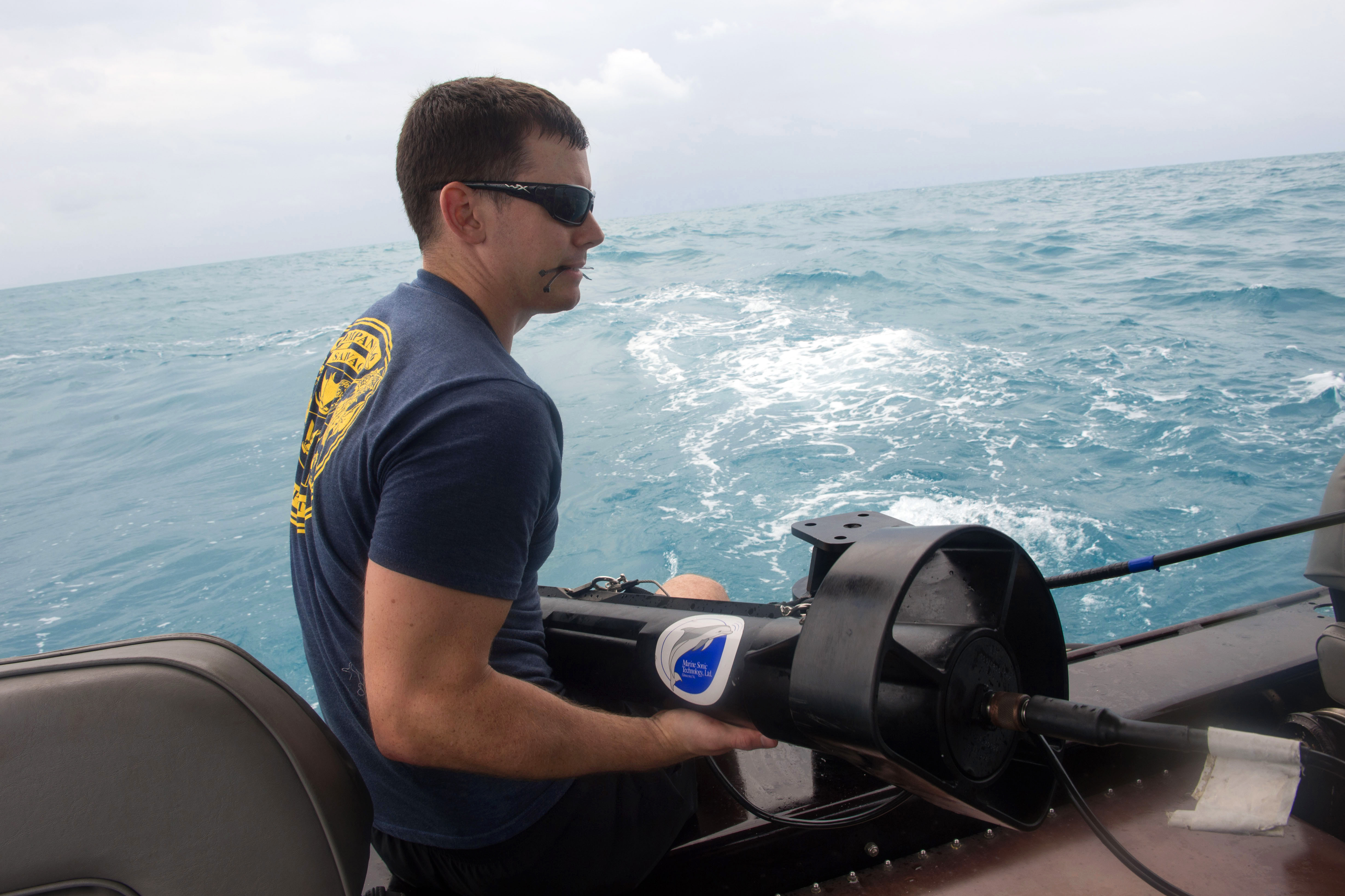 U.S. Navy Petty Officer 2nd Class Daniel Clarke prepares to launch a ...