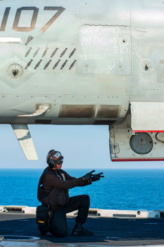 U.S. Navy Seaman Clinton Gibson starts the engines for an F/A-18F Super ...