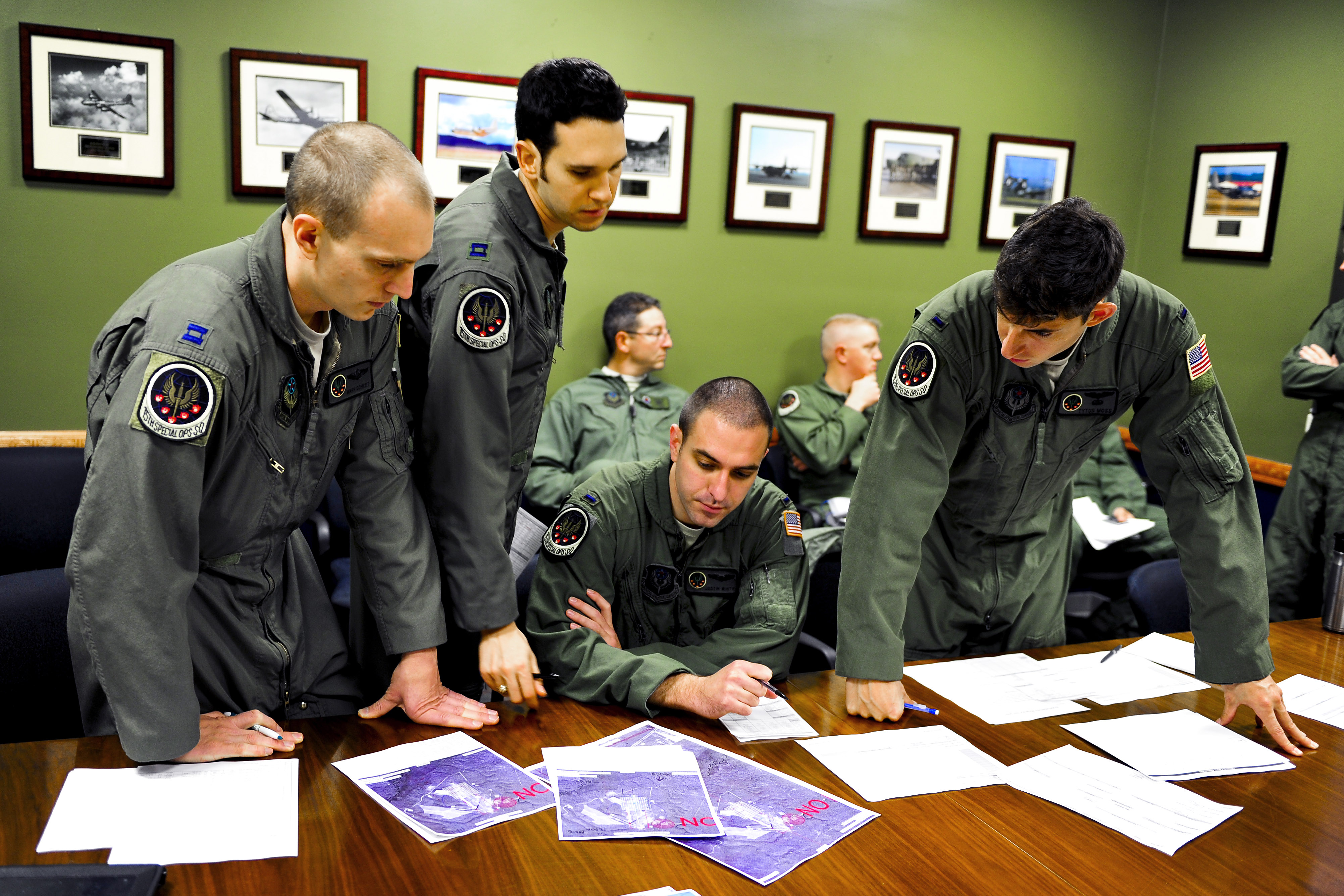 Air Force pilots and mission trainers go over flight plans on Hurlburt ...