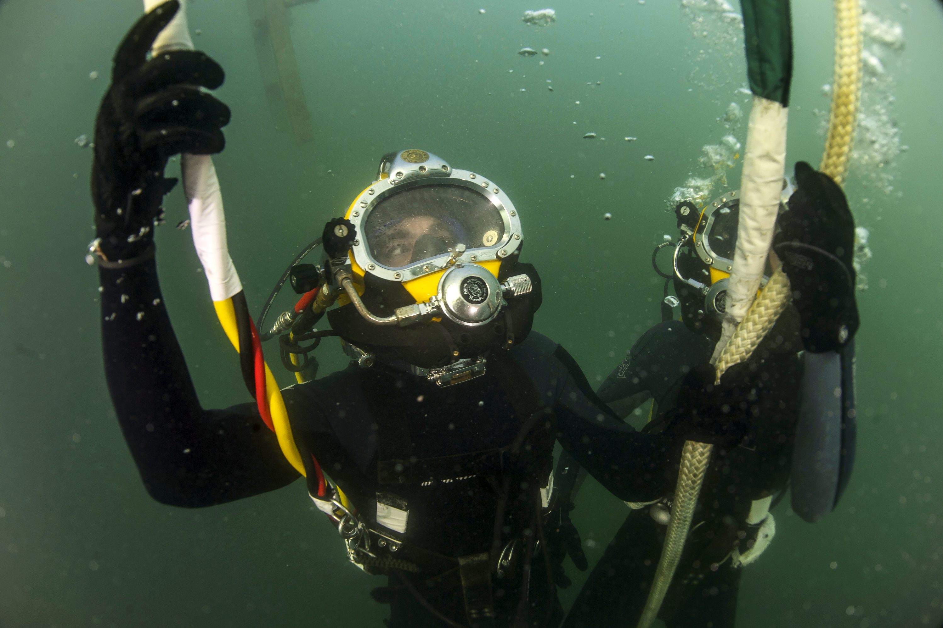 Navy seabee divers conduct surface supplied diving operations during ...