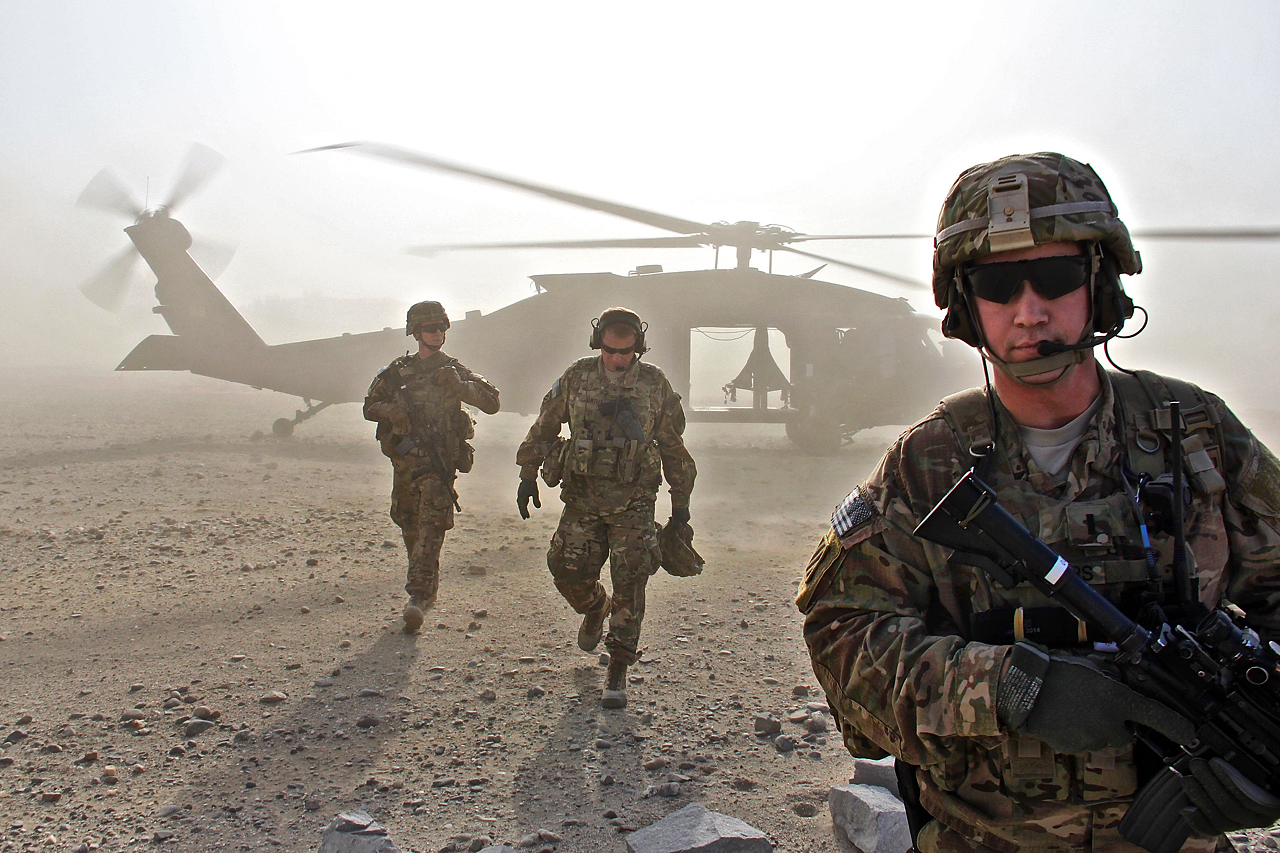 U.S. Army Spc. John Gilbert, left, U.S. Army Brig. Gen. Christopher ...