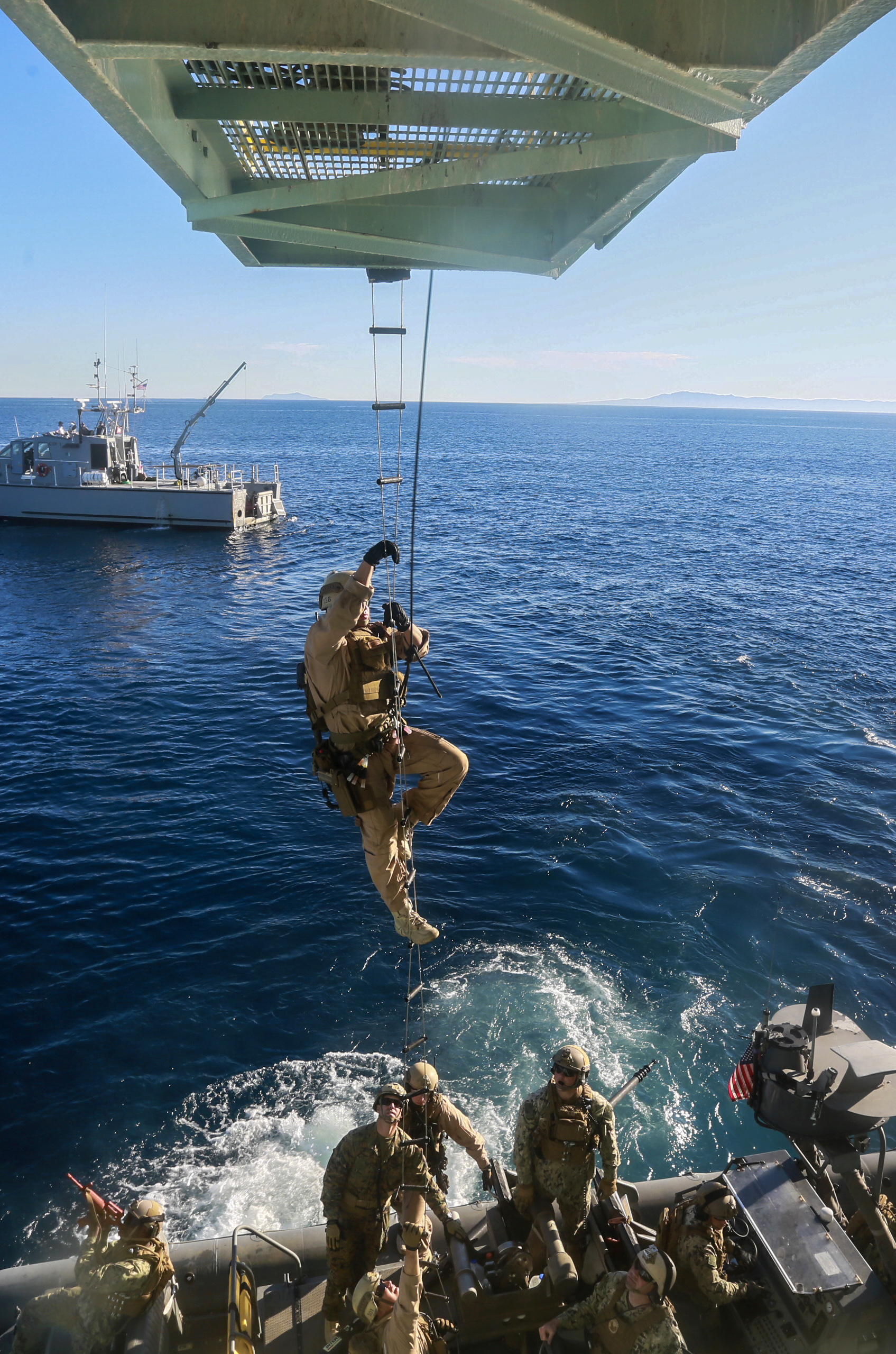 A Marine climbs a caving ladder to board a gas and oil platform during ...