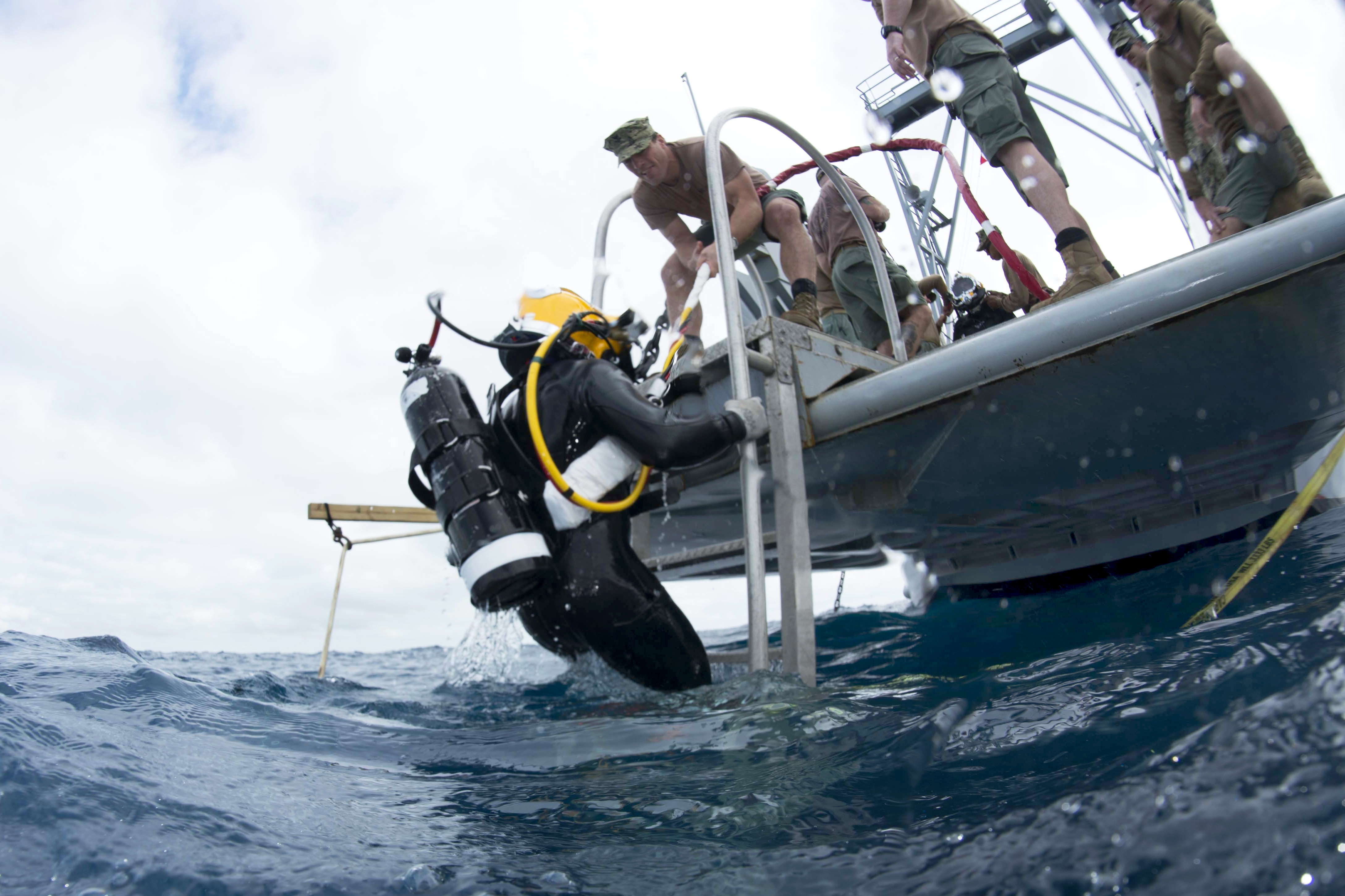 Navy Petty Officer 1st Class Carlos Hernandez ascends a ladder during ...