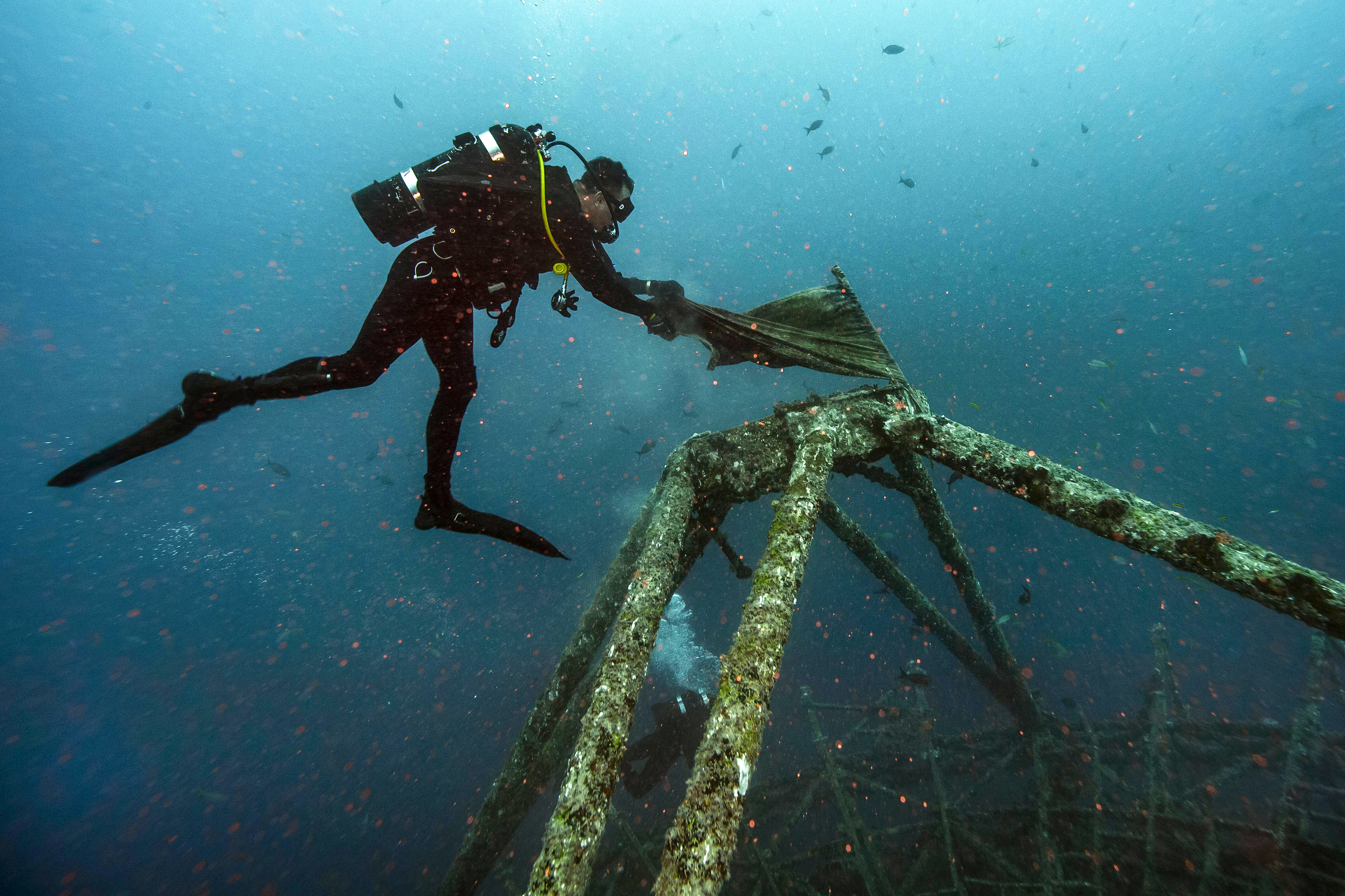 Navy Chief Petty Officer Peter M. David shakes off the sediment on an ...