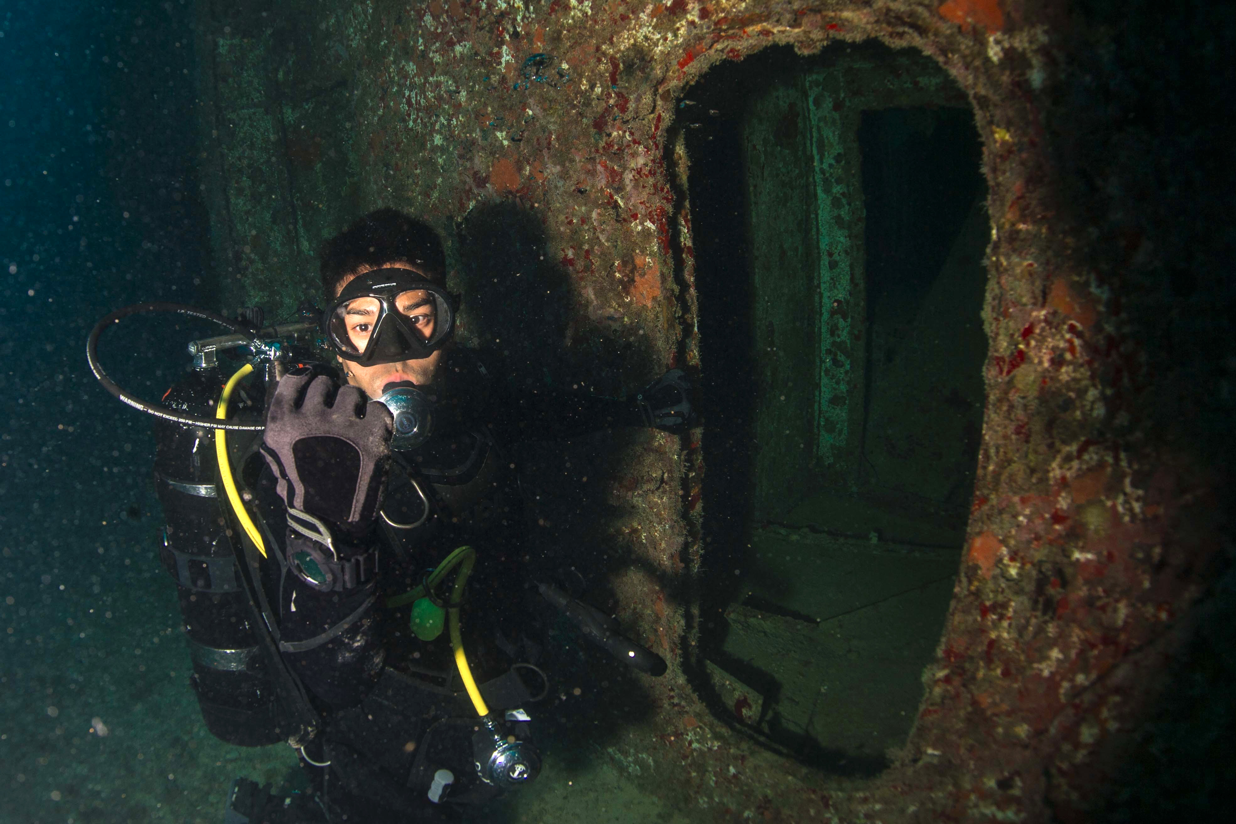 Navy Petty Officer 2nd Class Erick Martin dives on a wreck during diver ...
