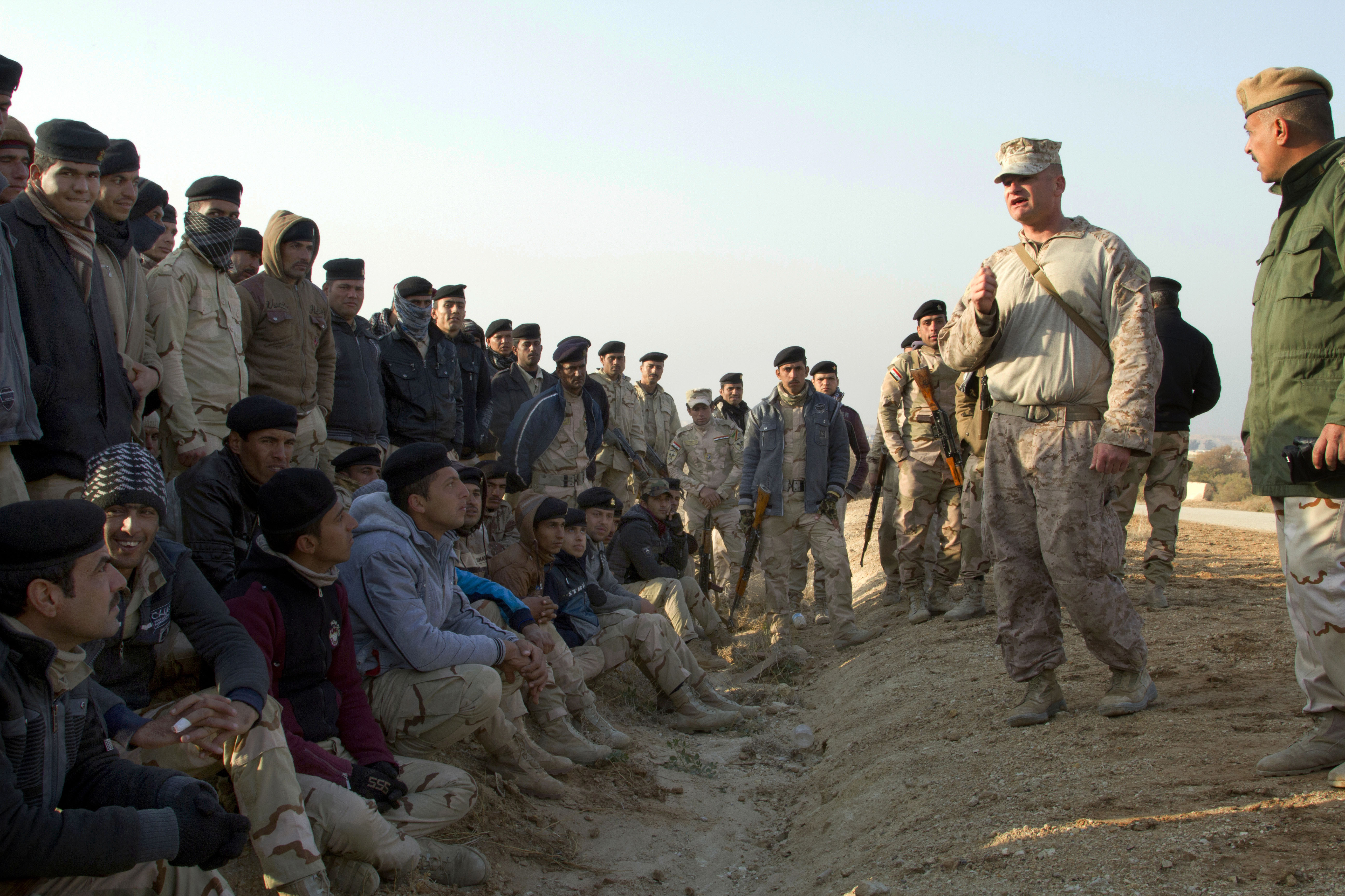 U.S. Marine Corps Maj Brandon Stibb, second from right, speaks to Iraqi ...