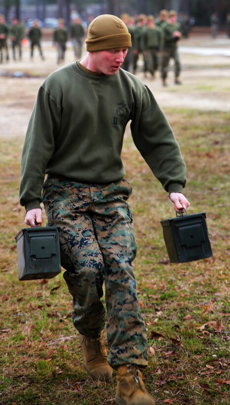 A Marine participates in an ammo-can relay race while competing in the ...