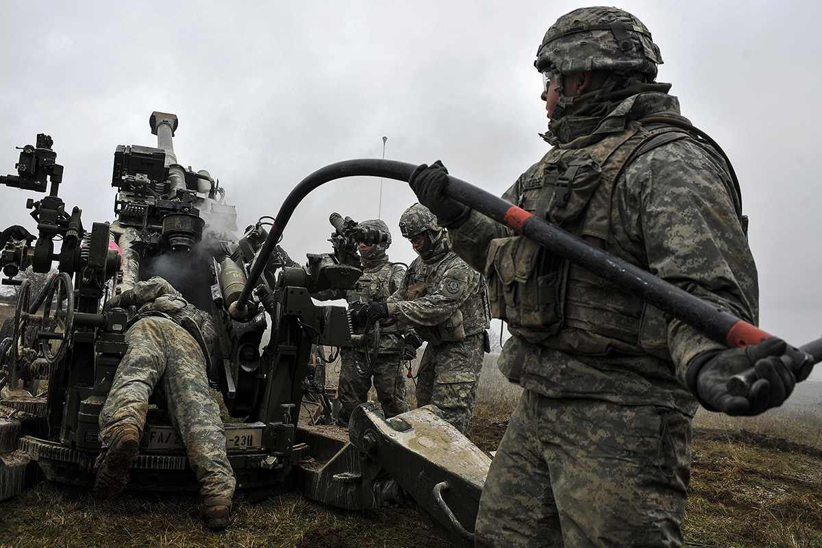 U.S. soldiers load an M777 howitzer during a live-fire exercise at the ...