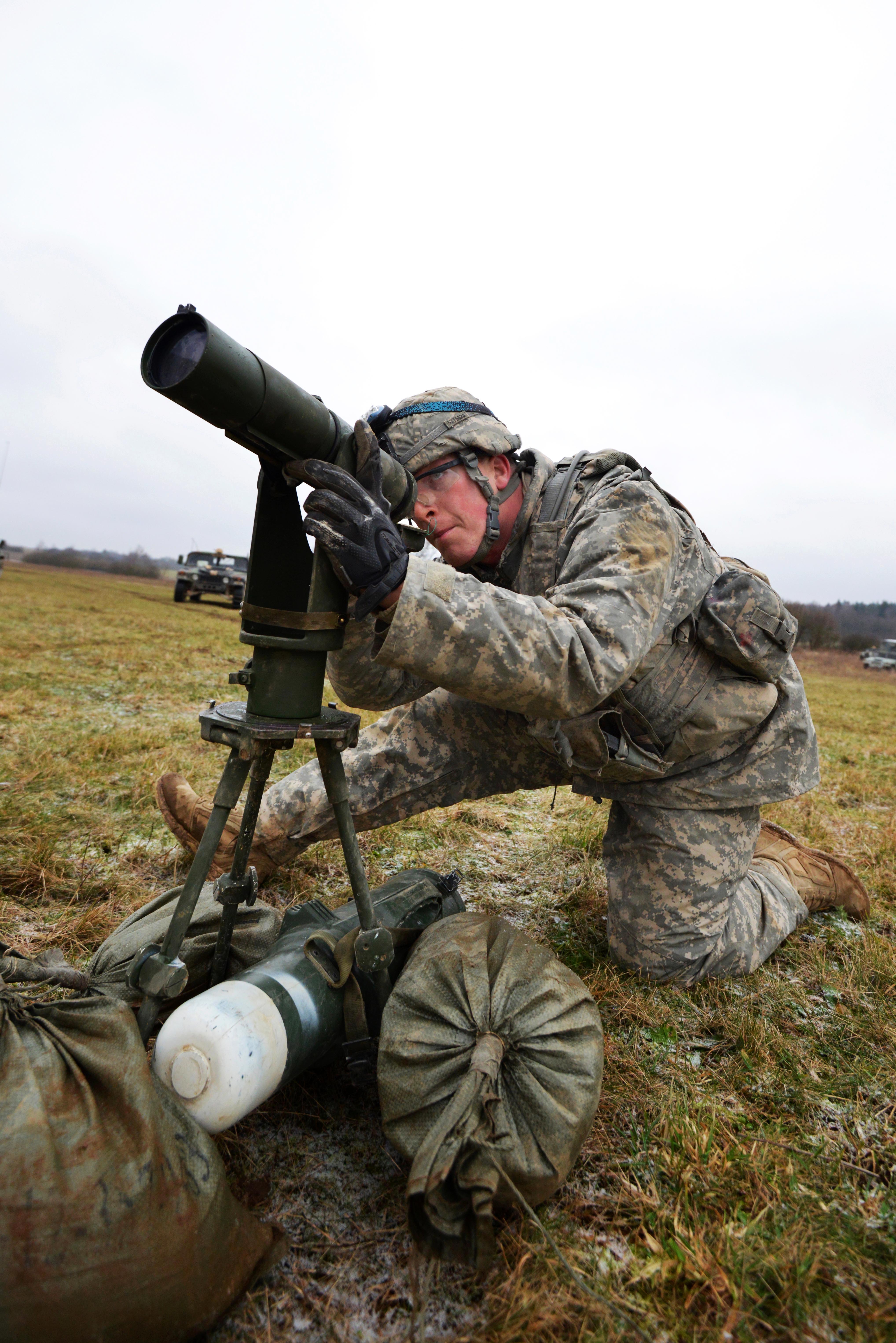 U.S. Army Spc. Torance Tate aligns the howitzer's gunner's sight using ...