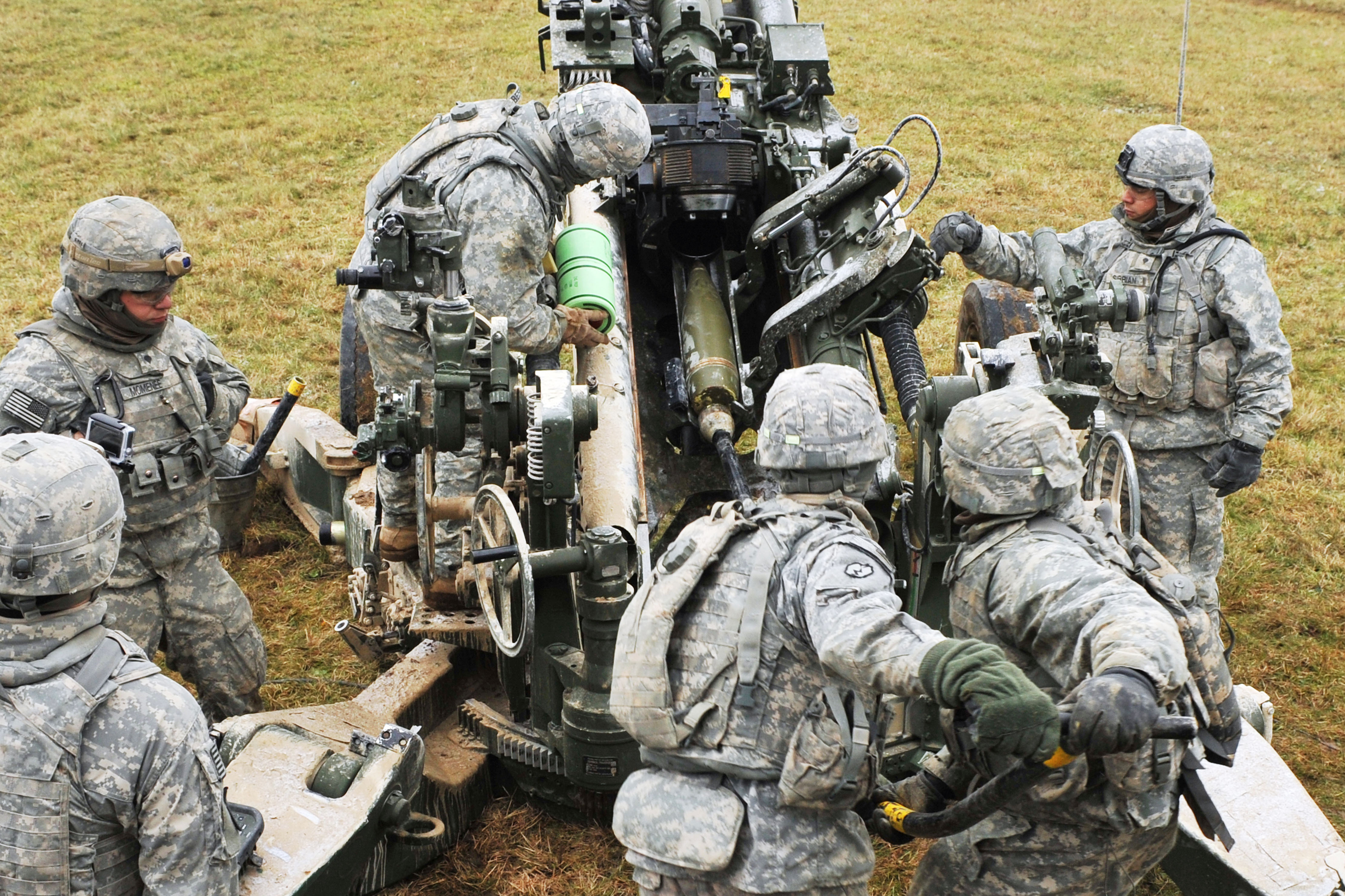 U.S. soldiers load an M777 howitzer during a live-fire exercise at the ...
