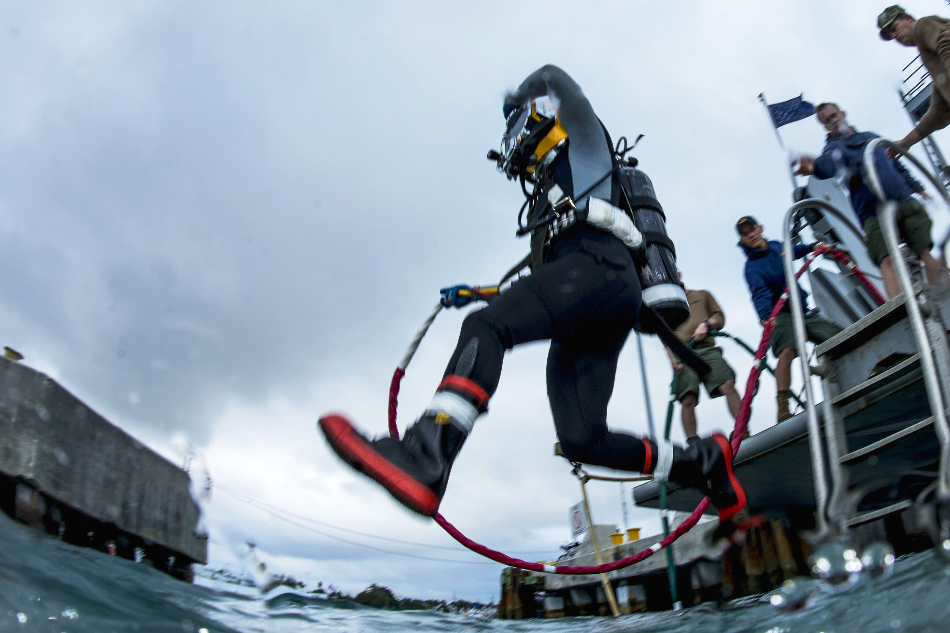 Navy Petty Officer 2nd Class David Madmon conducts a surface supplied ...