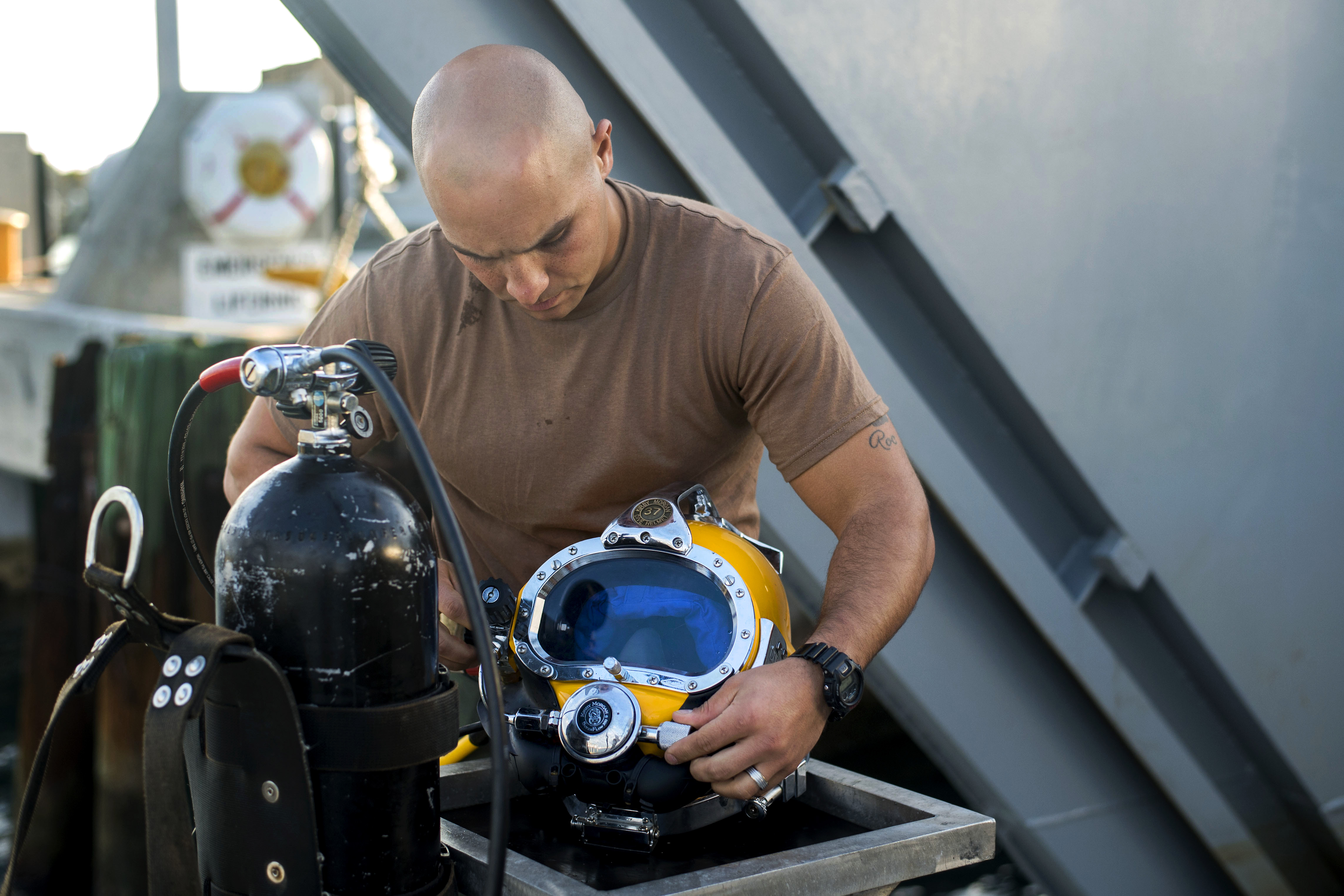 Navy Petty Officer 2nd Class Joseph Rodriguez performs pre-dive ...