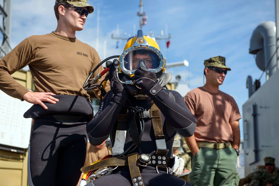 Navy Lt. Thomas D. Hallam prepares to conduct a surface-supplied ...