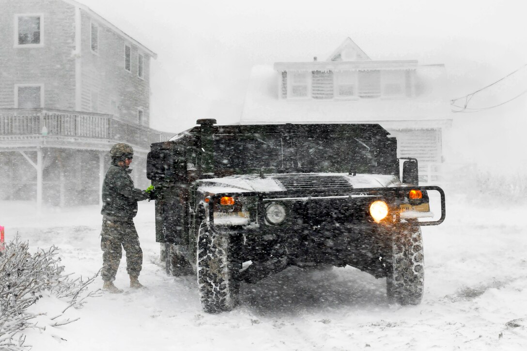 Soldiers work with Scituate Police and Fire Department members to ...