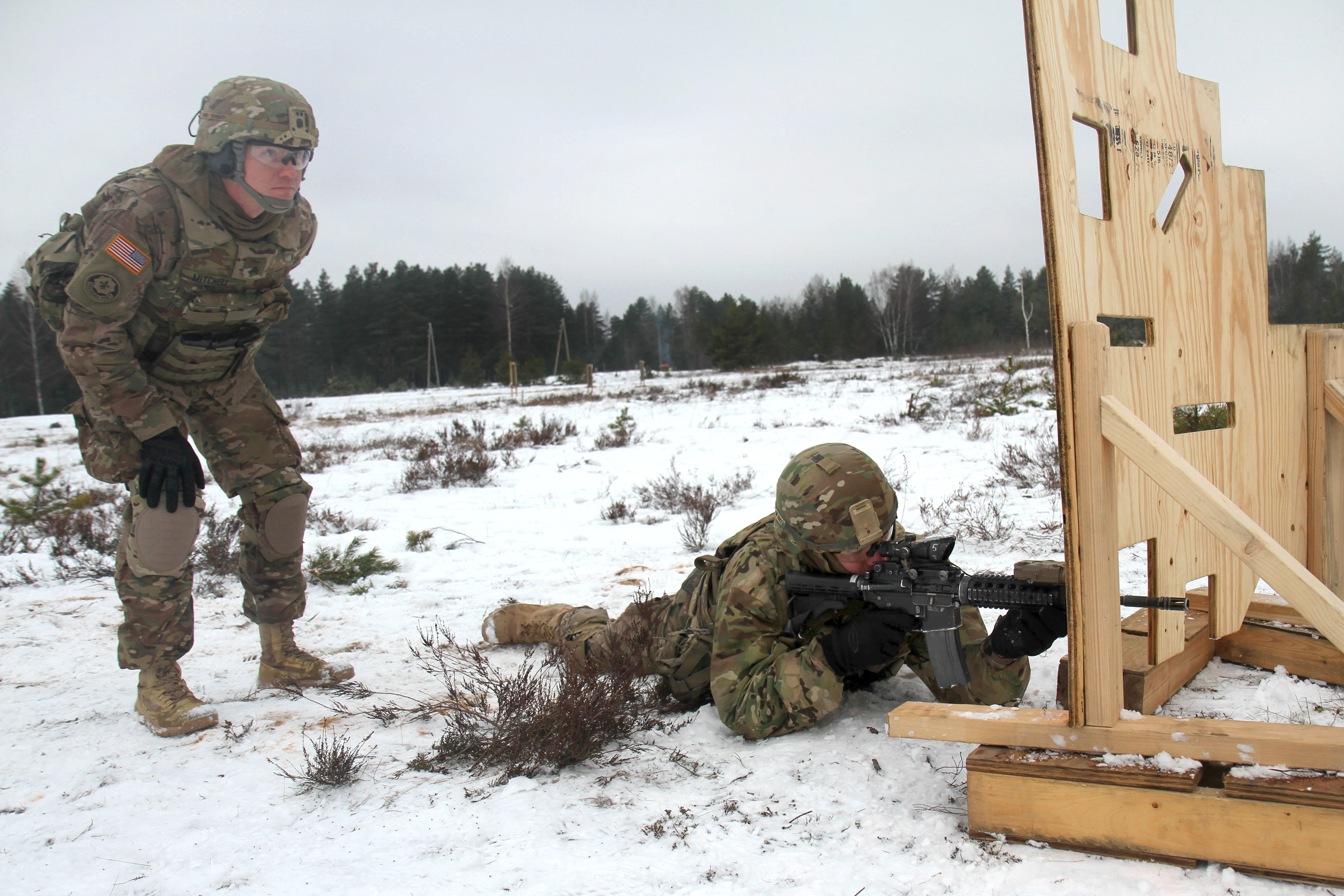 U.S. Army Sgt. Mitchell, left, observes another soldier firing his ...
