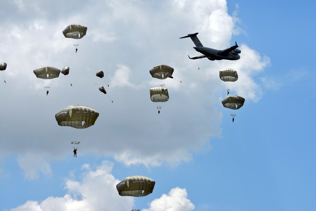 Army Rangers jump from a C-17 during military free-fall operations to ...
