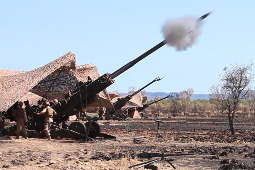 A U.S. Marine Corps M777A2 lightweight 155 mm howitzer fires a ...