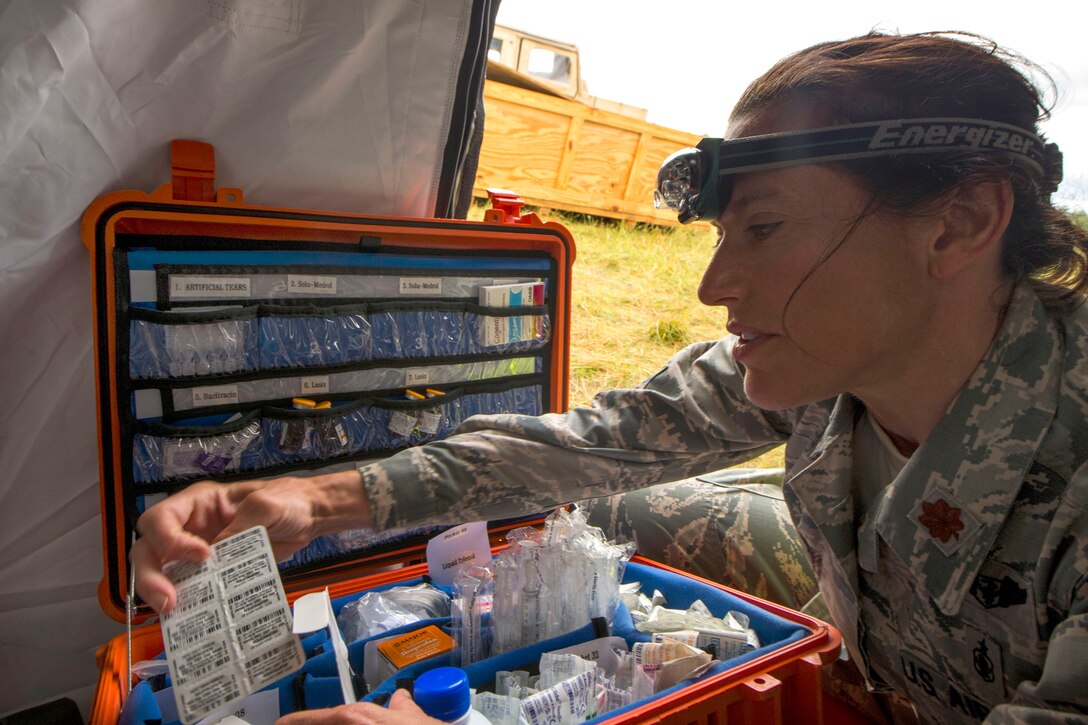 Air Force Maj. Carolyn Concia inventories medications before packing ...